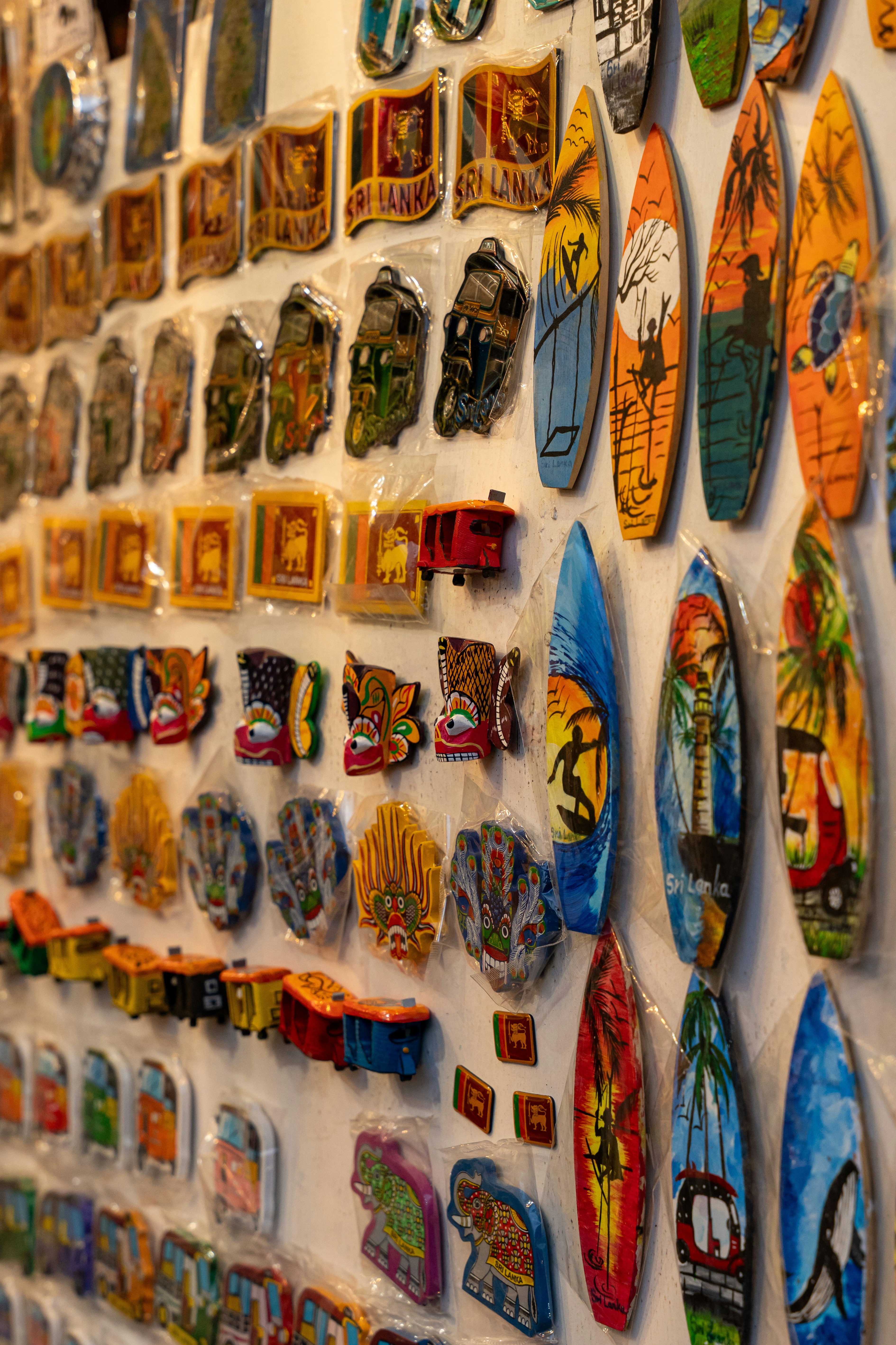 Vibrant Souvenir Alchemy: A Wall of Surfboard Magnets and Miniatures