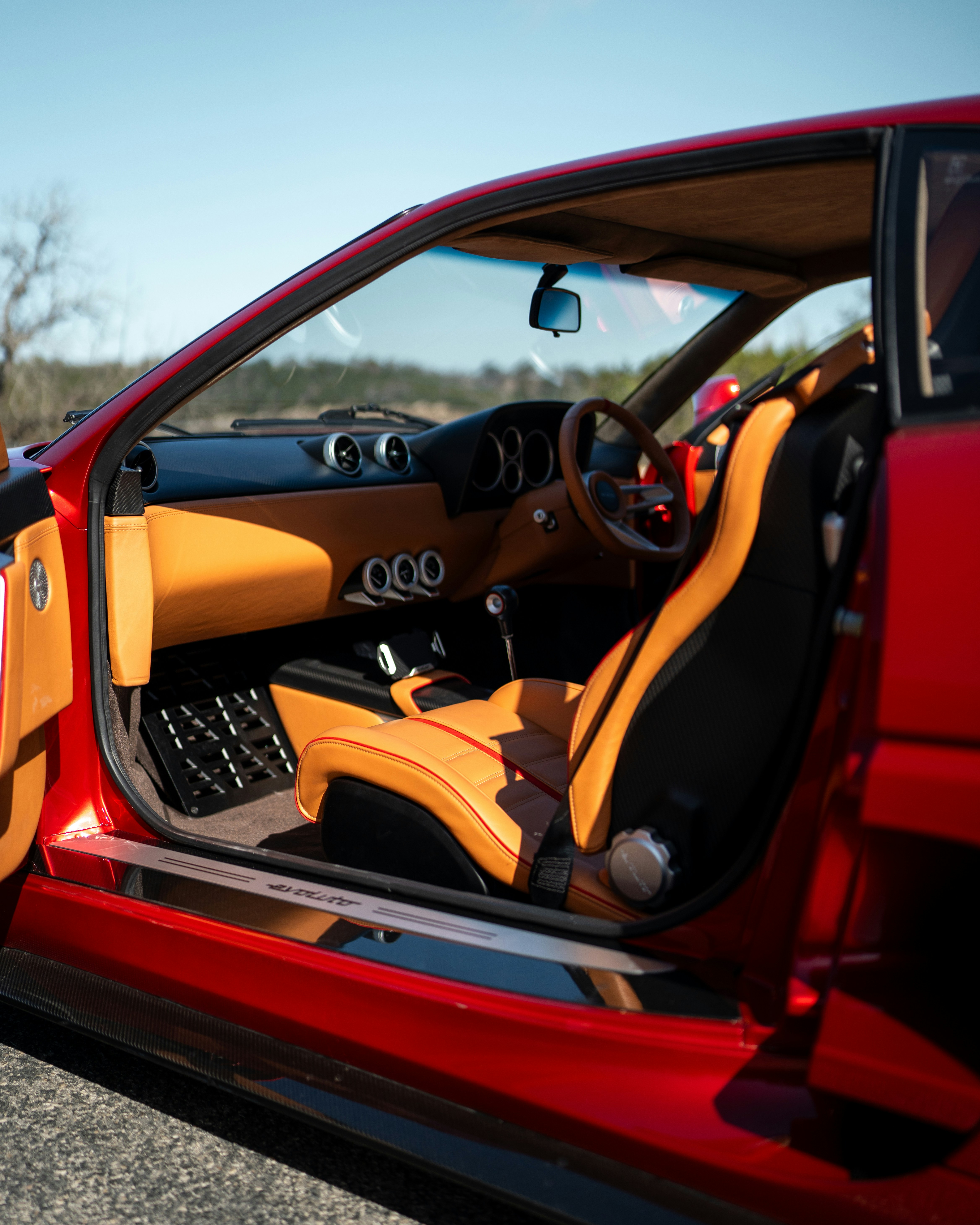 Lavish cockpit: amber leather and red metal in a classic sports car interior
