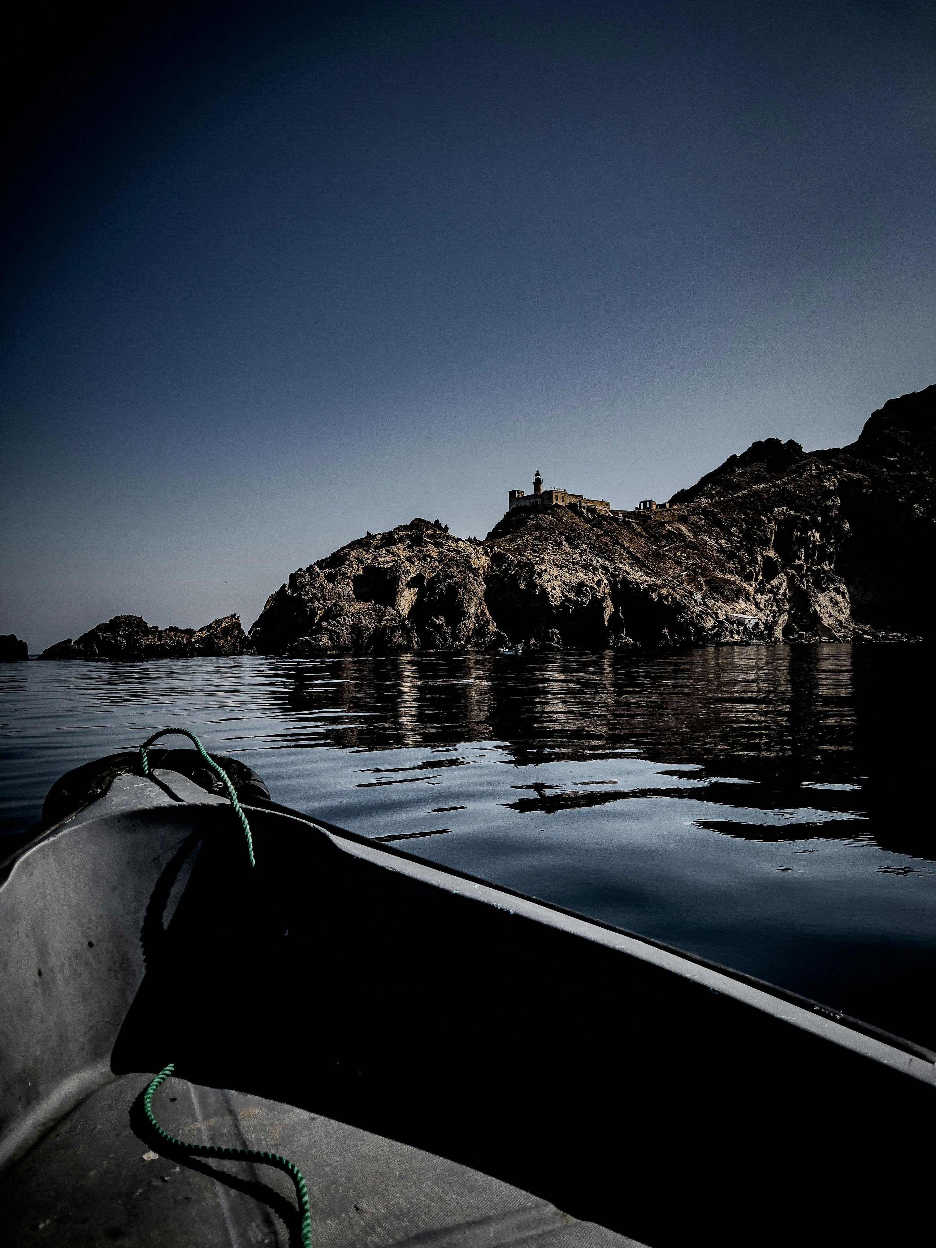 Bow of a Quiet Sea: A Lobed Horizon toward Coastal Rocks