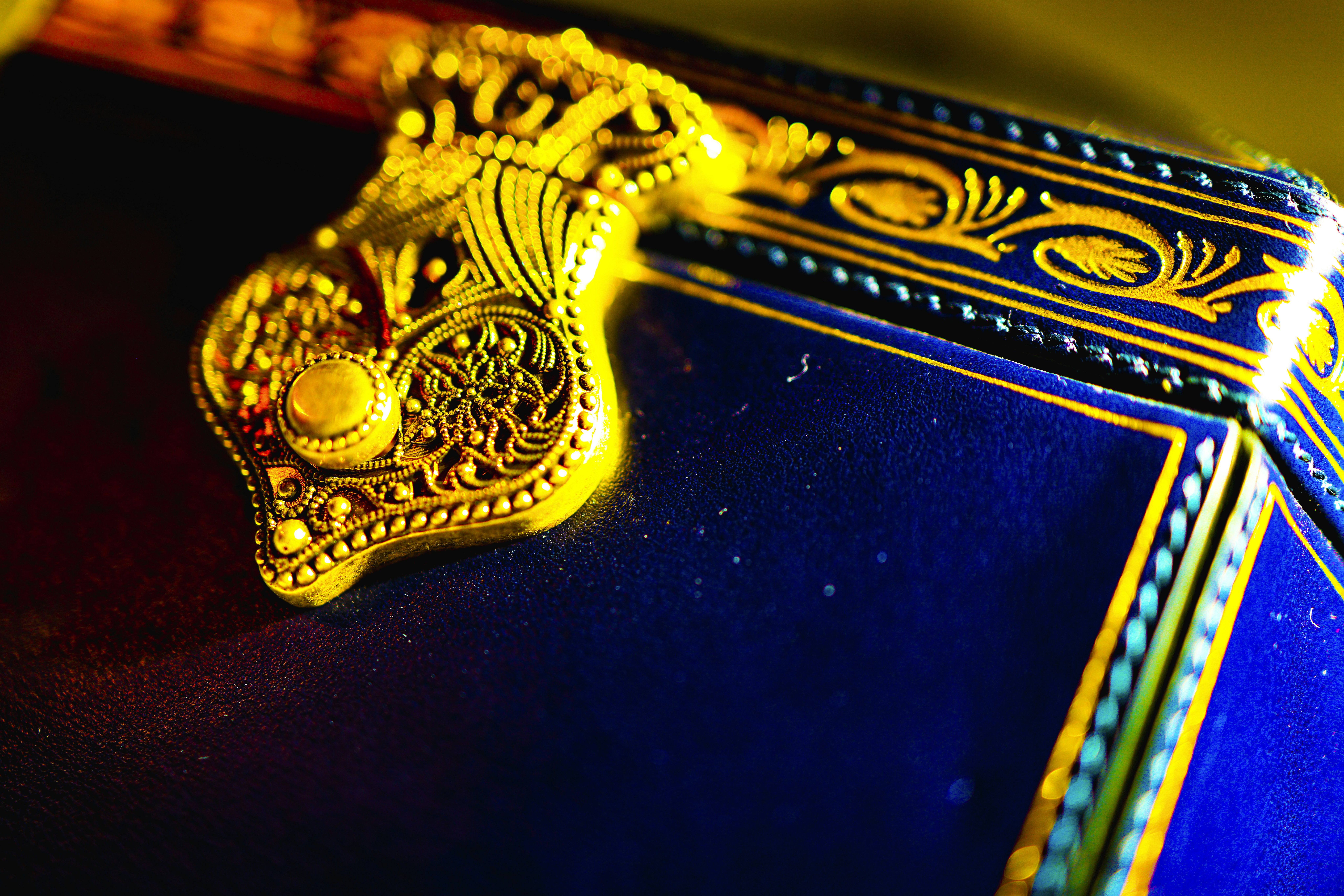 Ornate clasp on royal blue lacquer with gold filigree