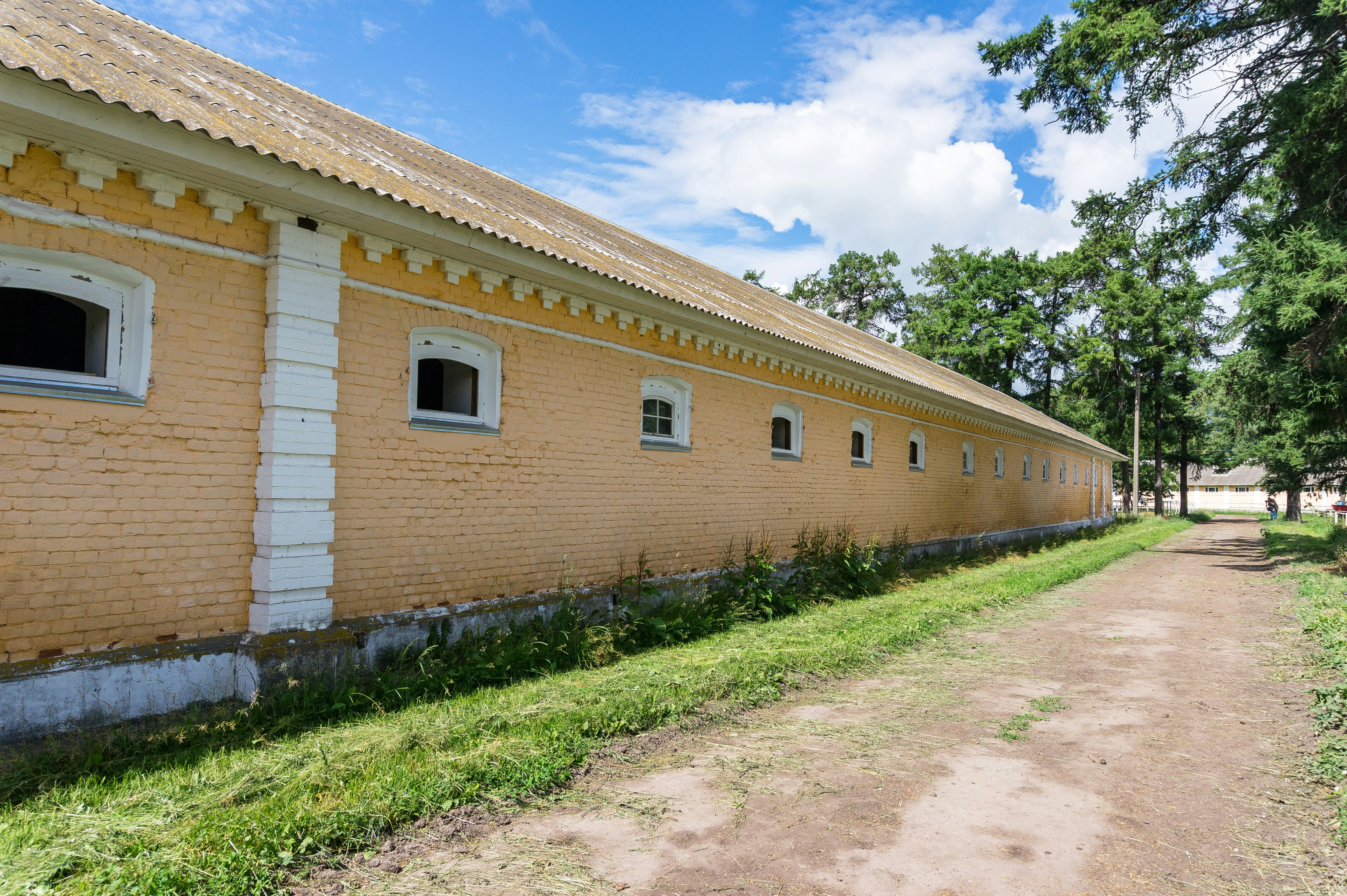Sunlit Brick Corridor: A Long-Footpath of Quiet Architecture