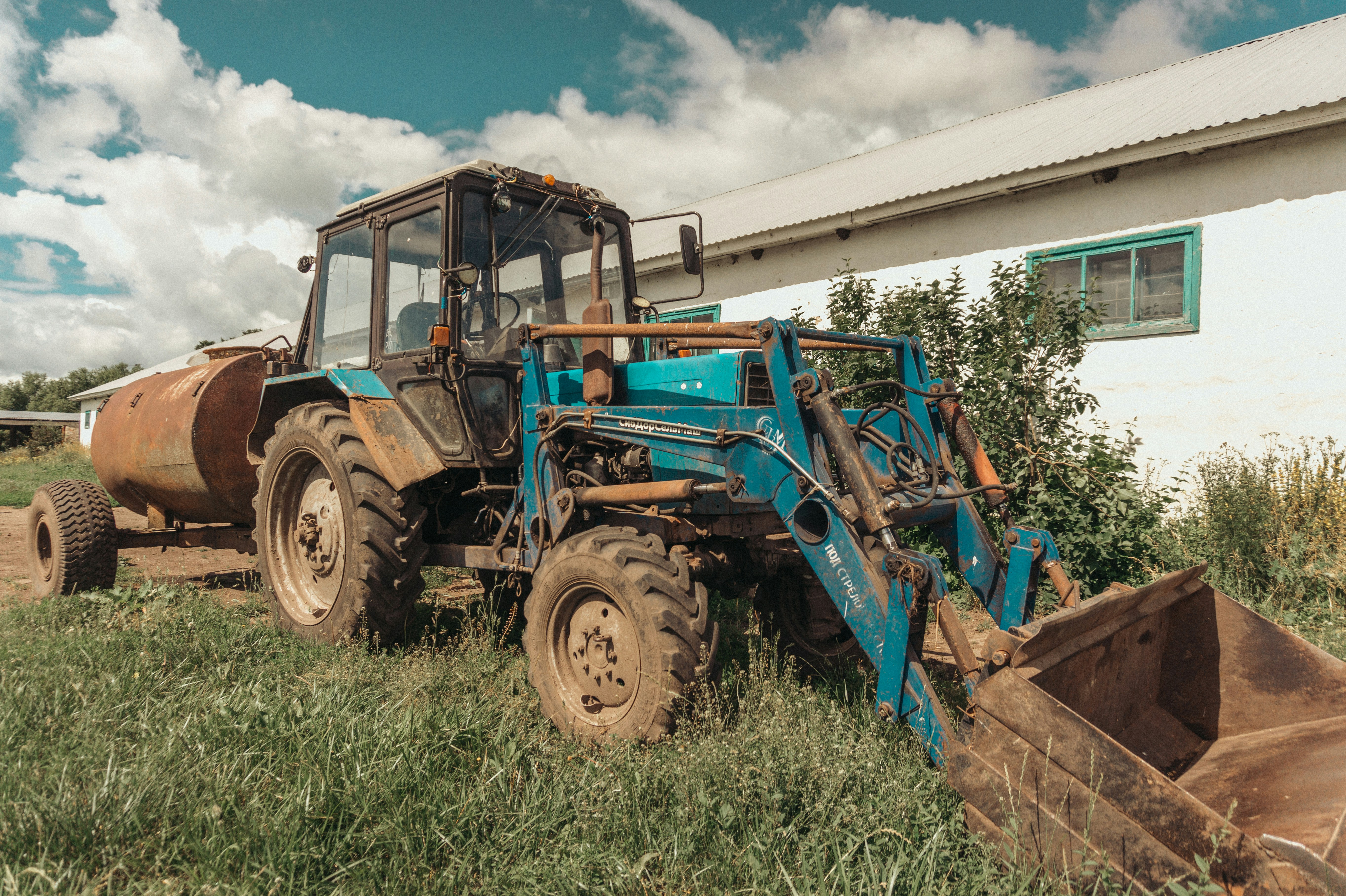 Weathered Tractor at Rest by the Barn
