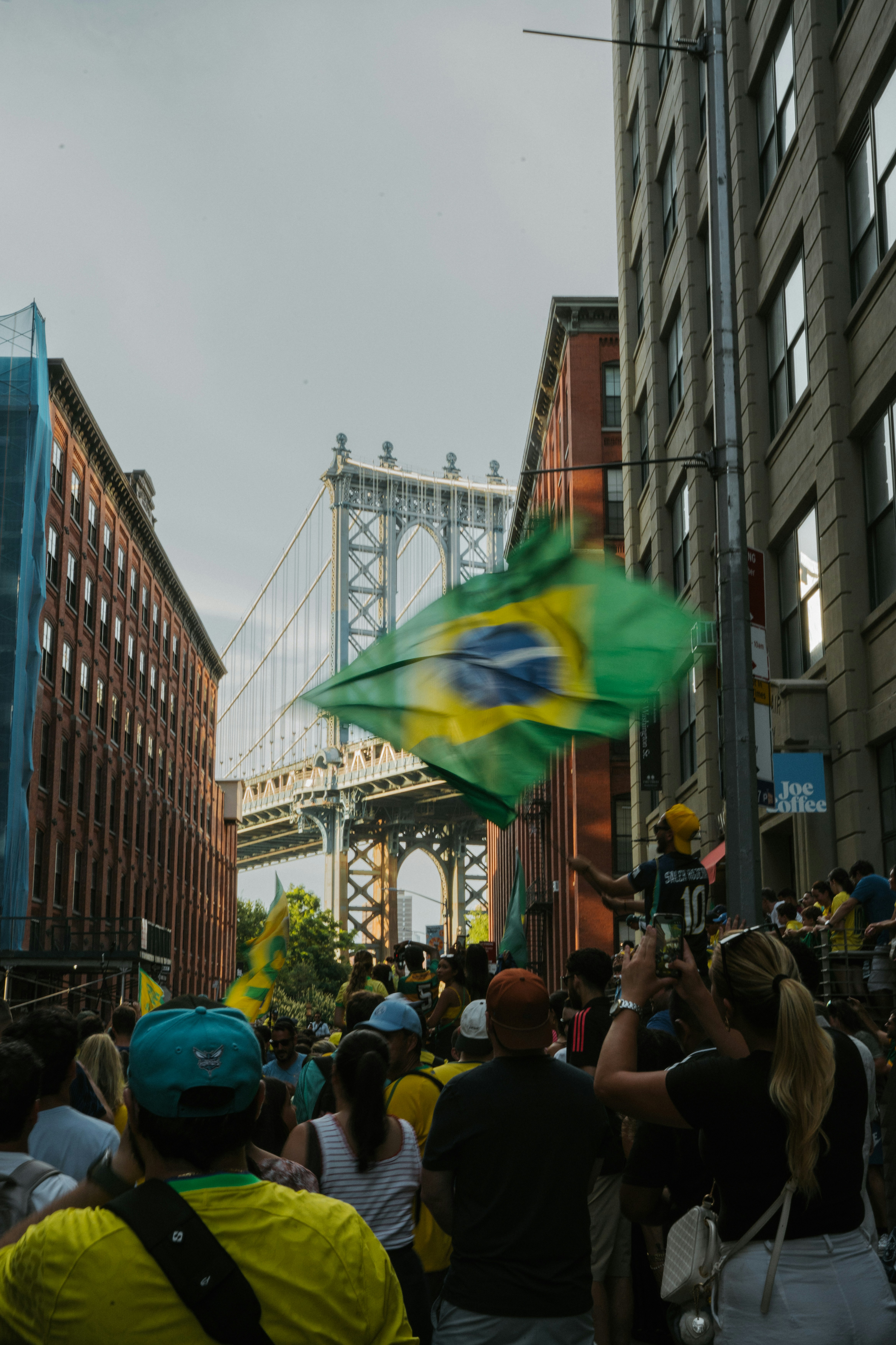  flags, city, and bridge: a crowded street scene beneath graf bridges