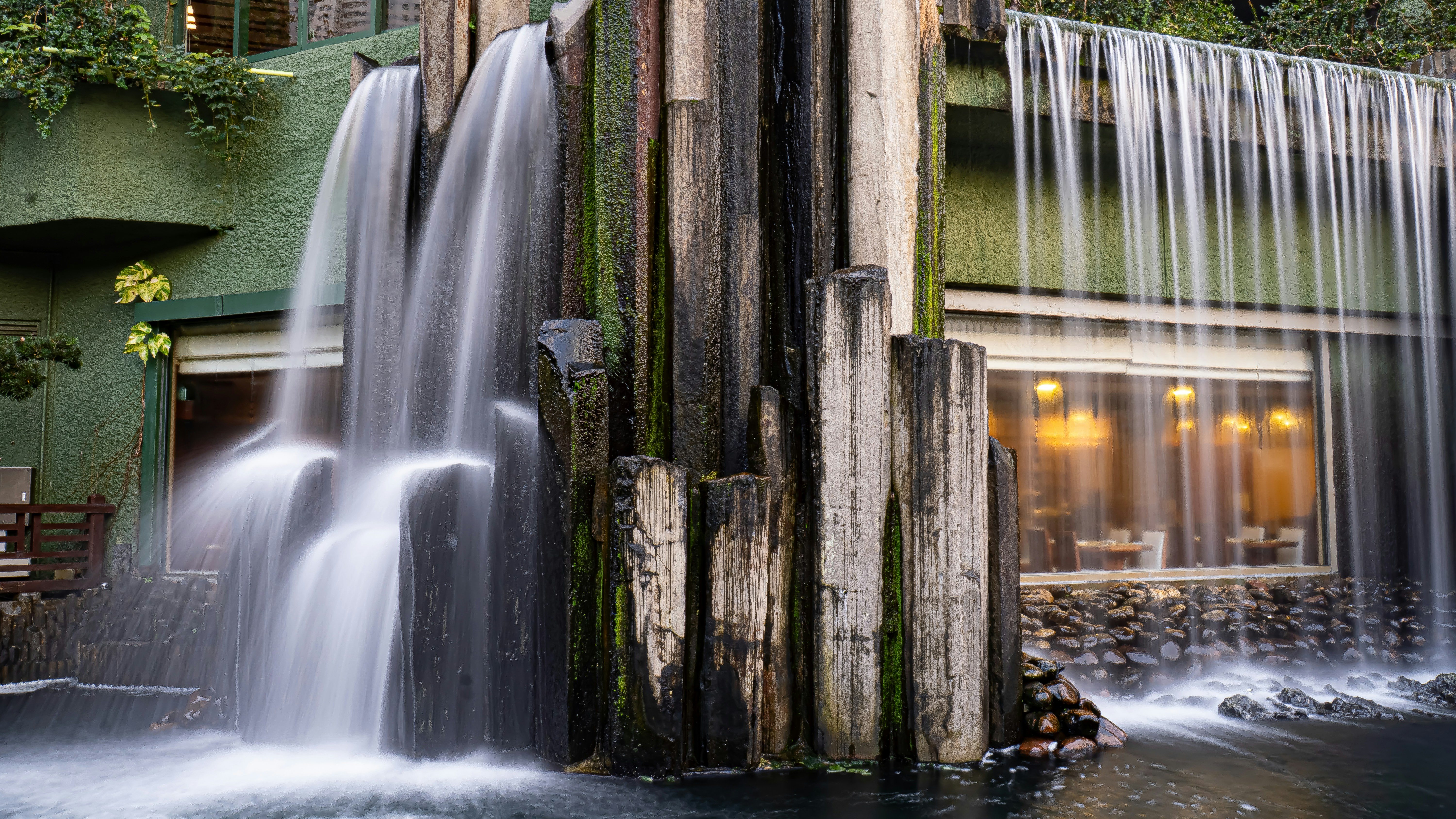 Industrial Cascades: A Waterfall Framed by Concrete Pillars
