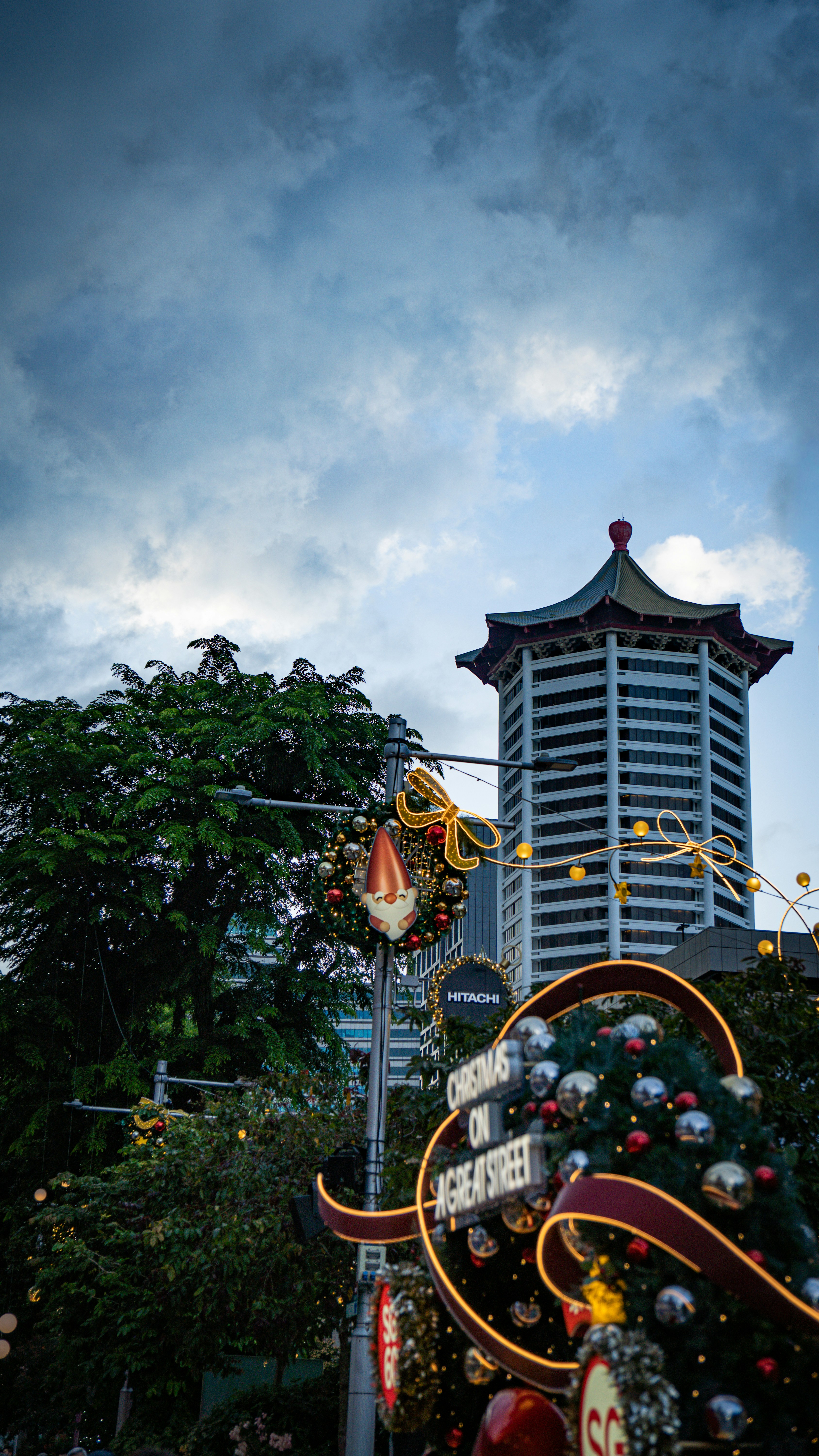 Towering Holiday Lights: A City Terrace Beneath a Cloudy Sky