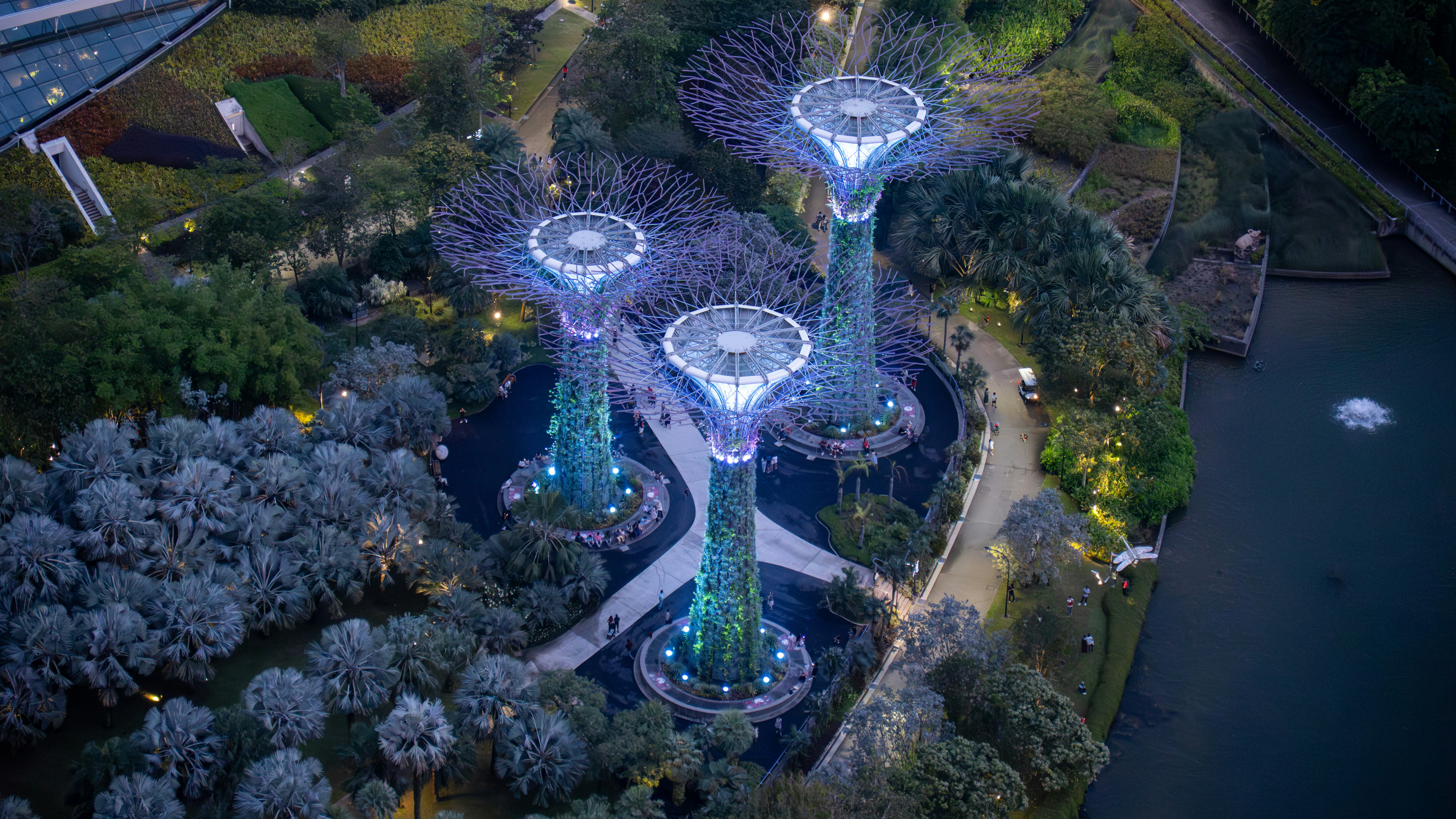 Illuminated Towers in a Serene River Park at Dusk