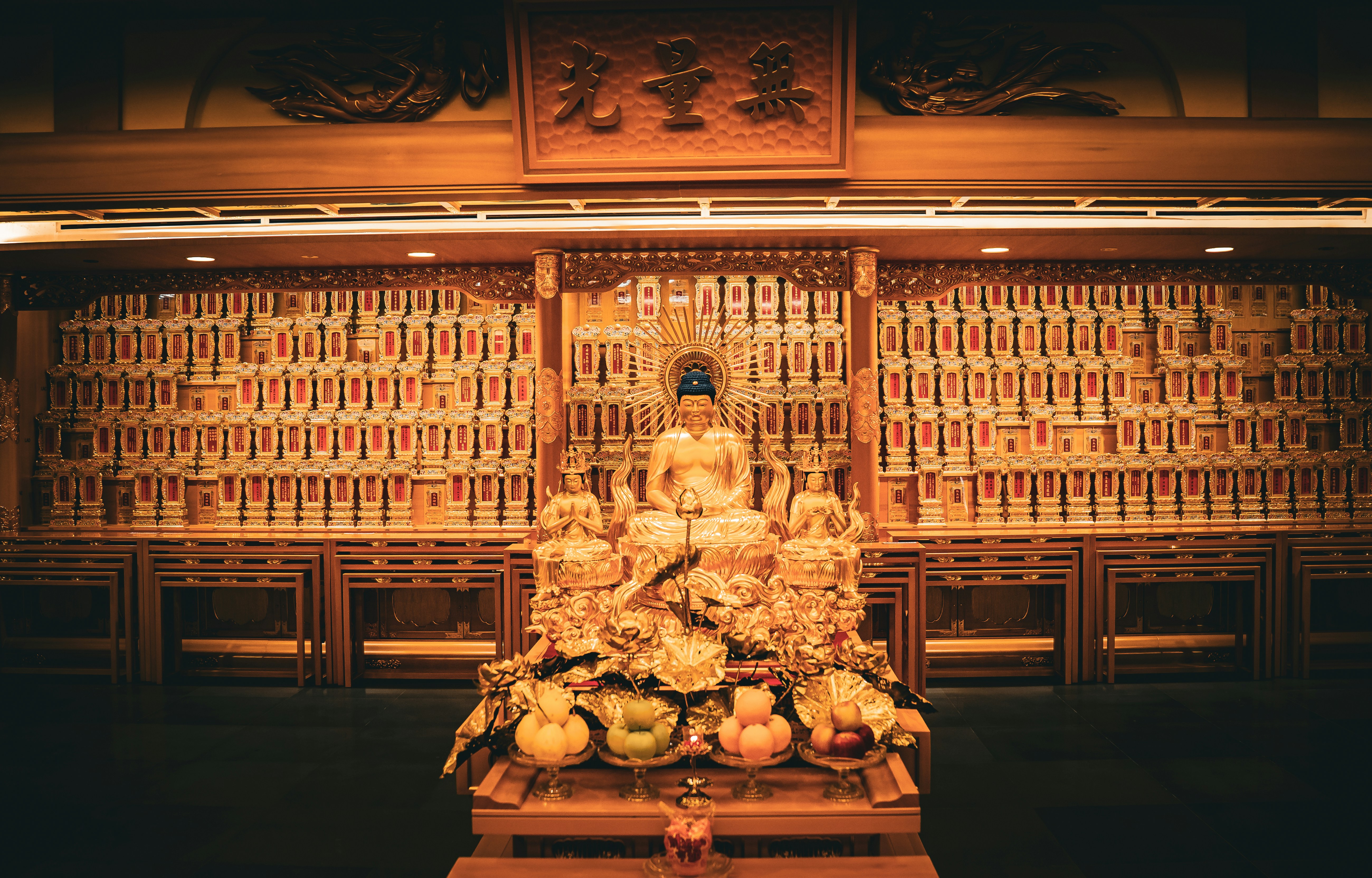 Centered Shrine of Golden Statues and Offerings
