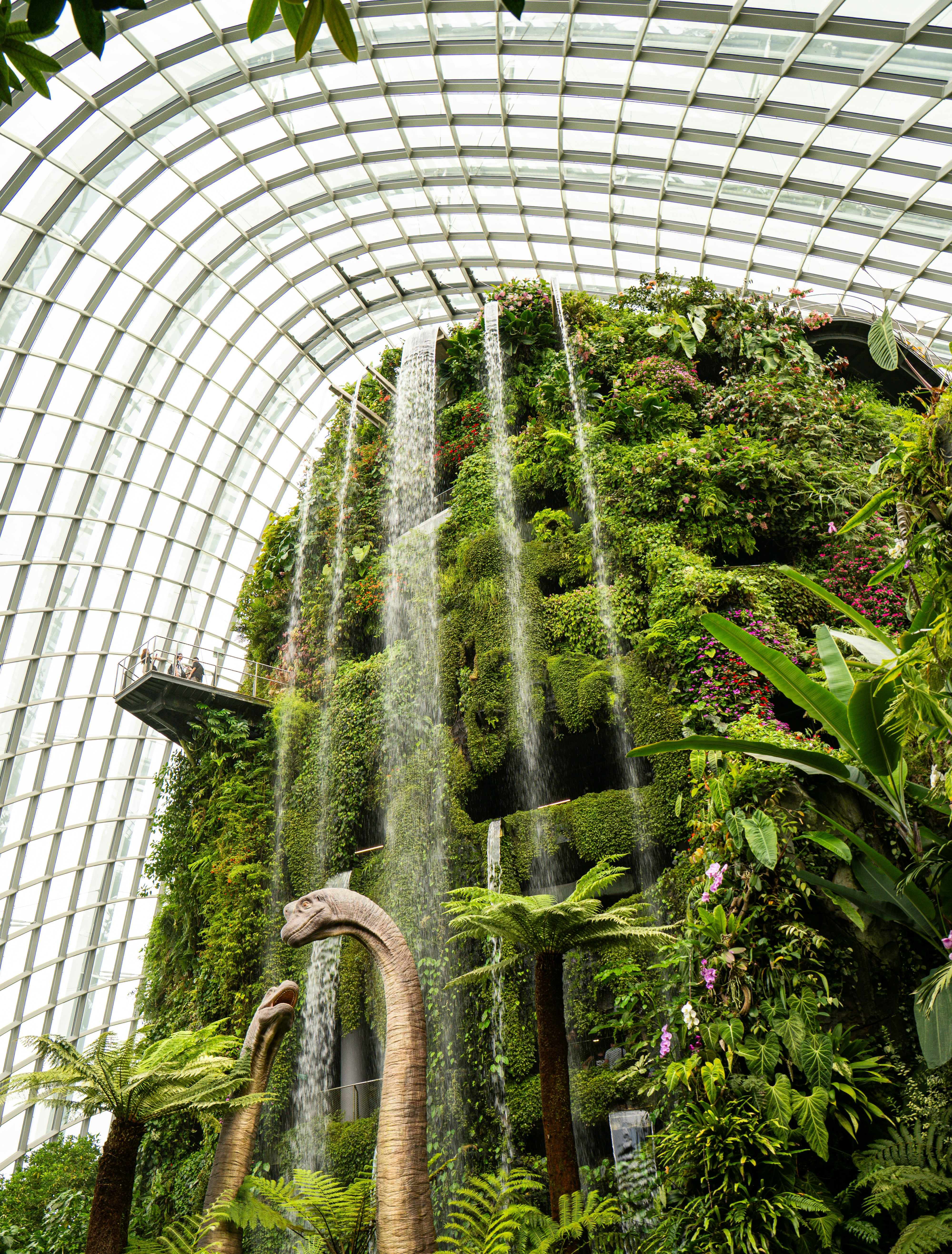 Vertical Garden cascade beneath a curved glass canopy