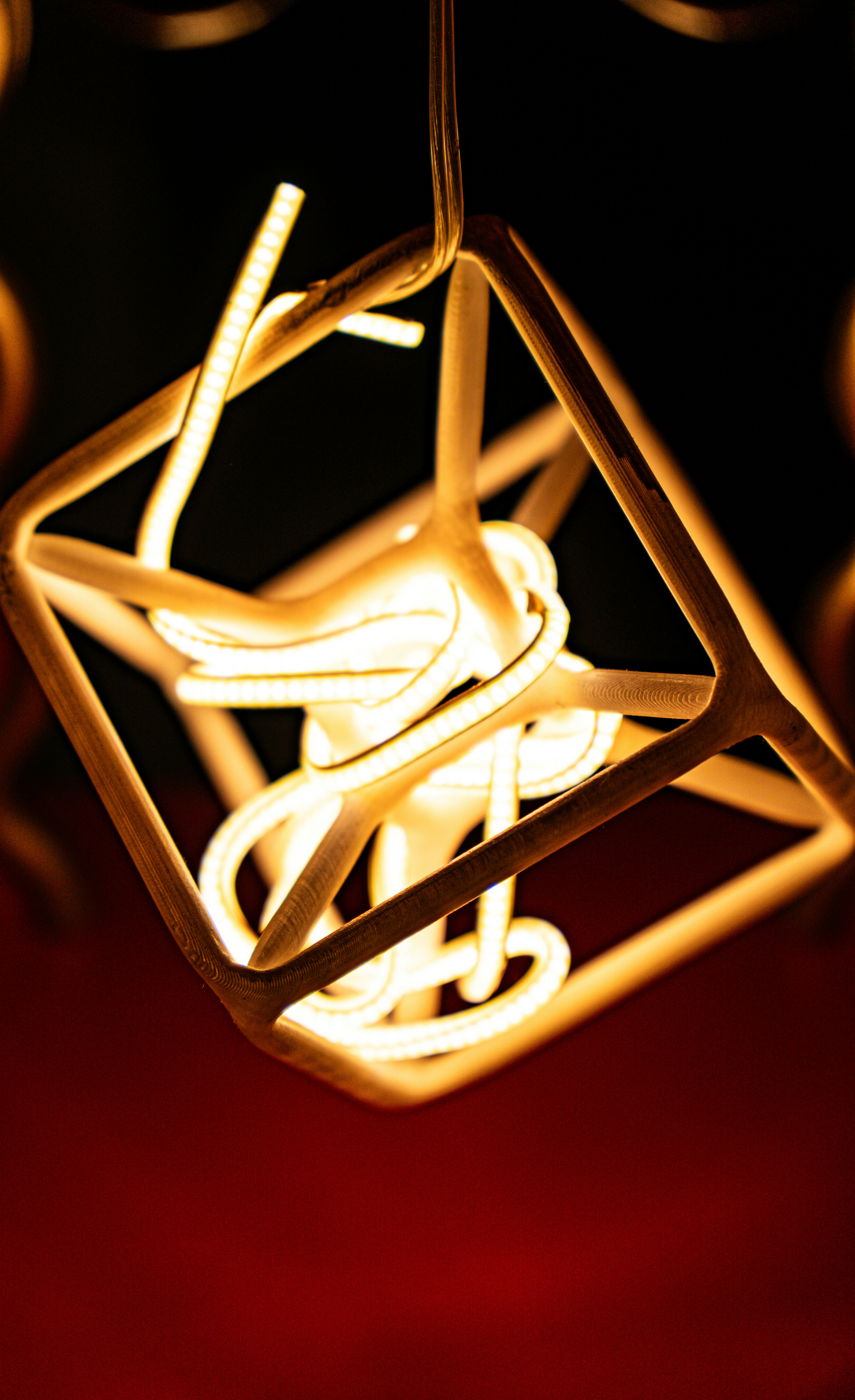 Glowing Geometric Nest: An Illuminated Wireframe Loop in a Copper Cube