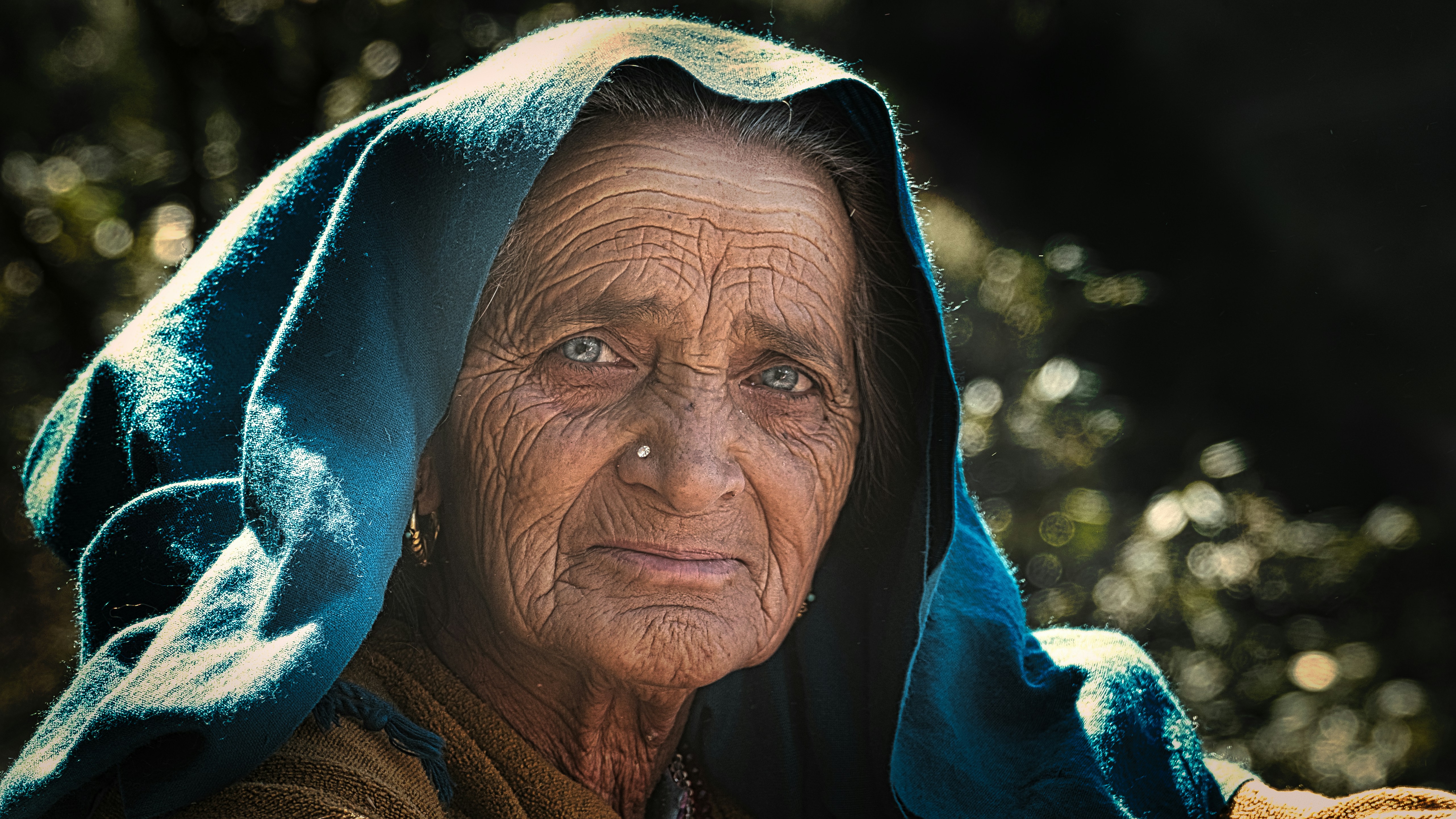 Veil of Time: An Elder's Quiet Gaze in Dappled Light