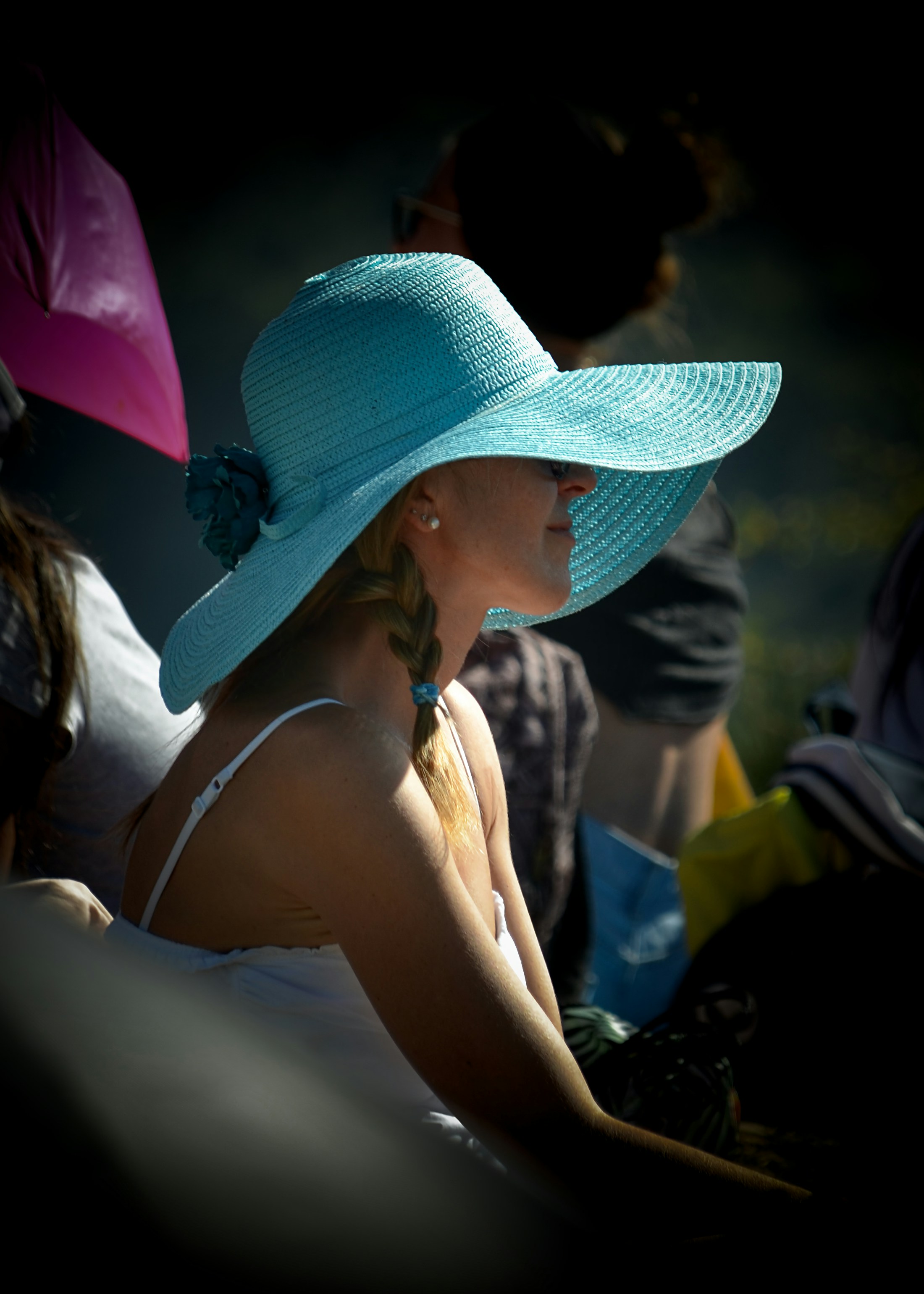 Azure Hat, Quiet Spotlight: A Sunlit Moment on the Beach