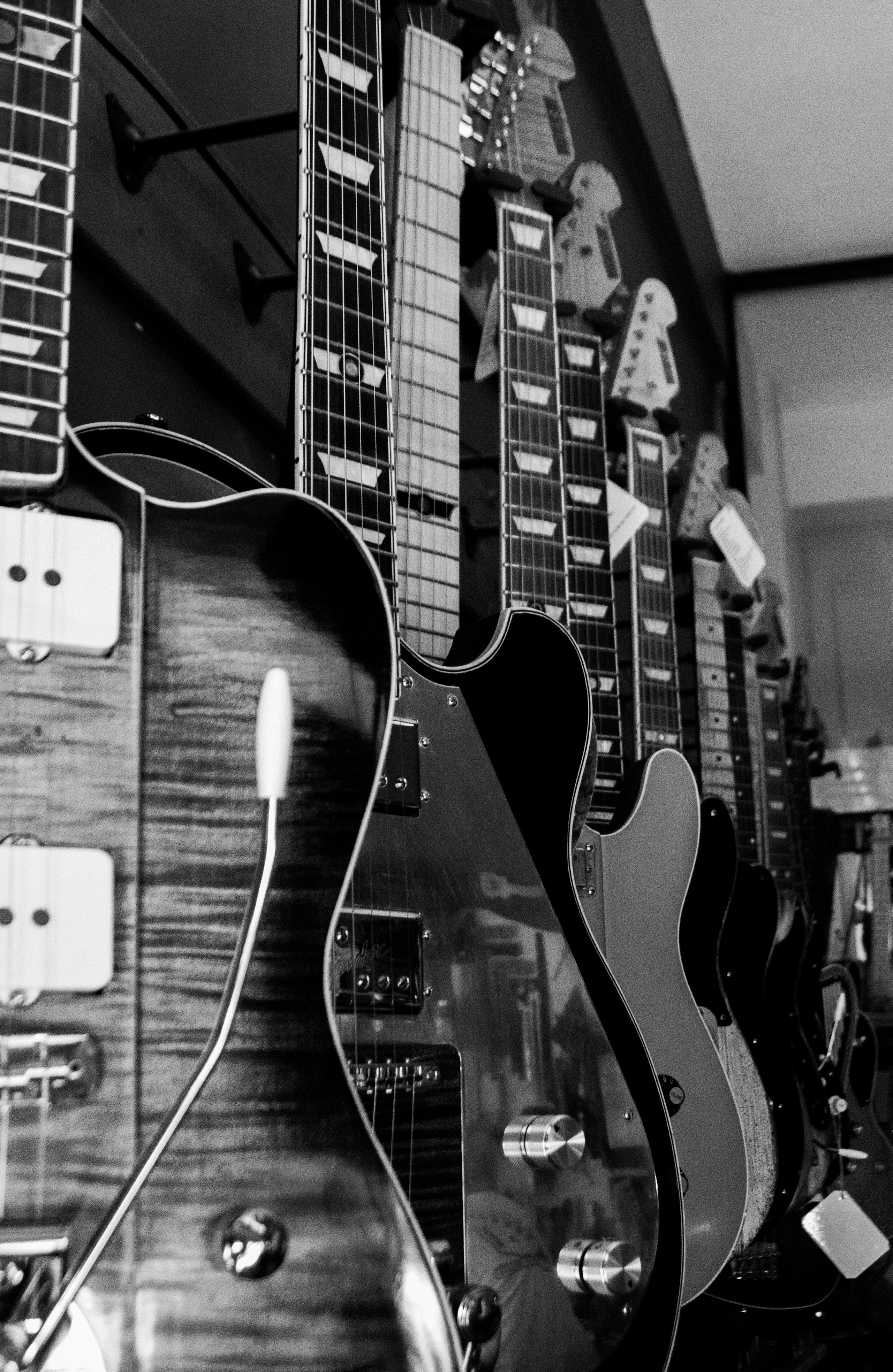 Row of Heritage Guitars: A monochrome gallery of strings