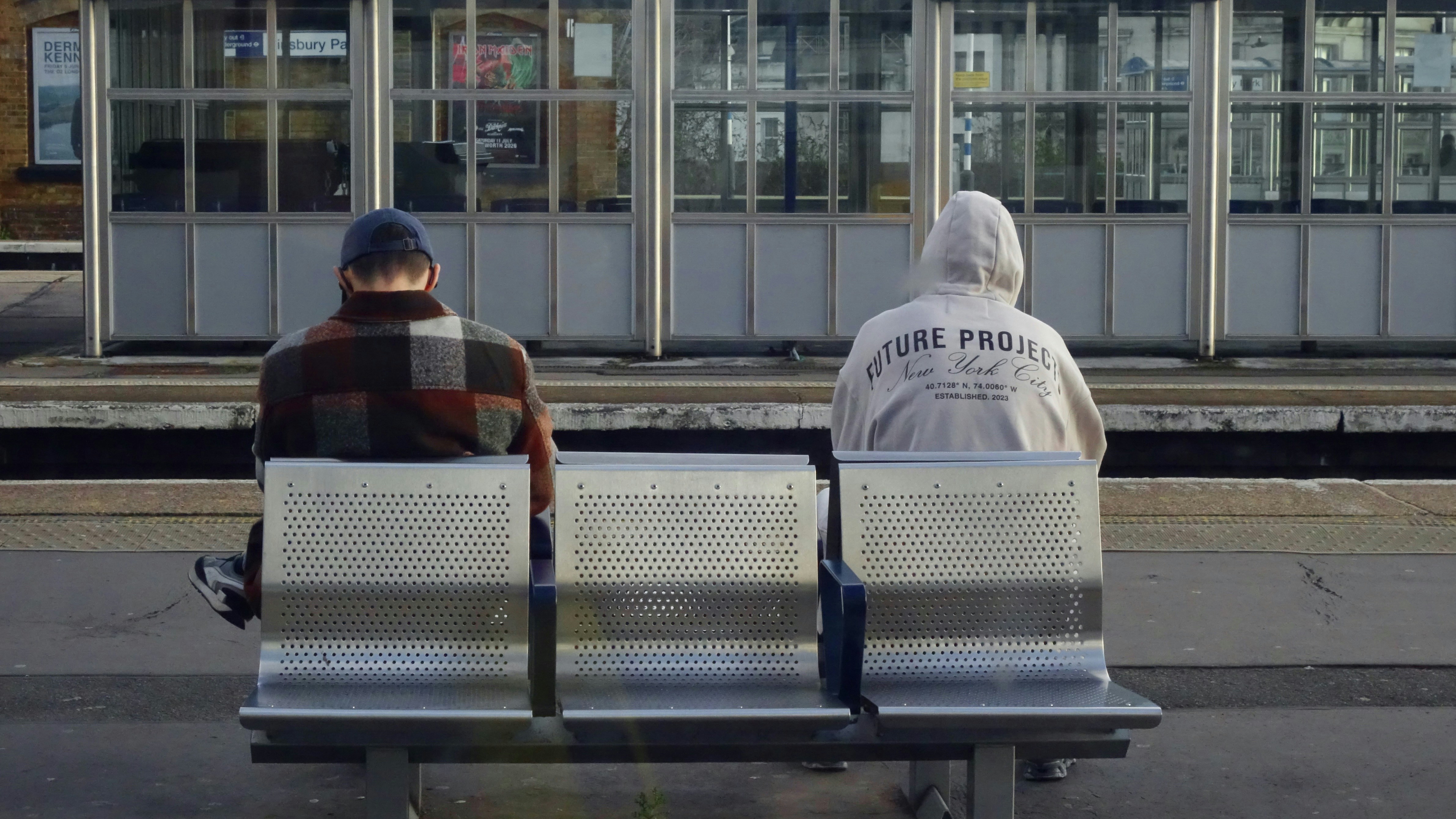 Two Figures, One Quiet Platform: A Pause Between Journeys