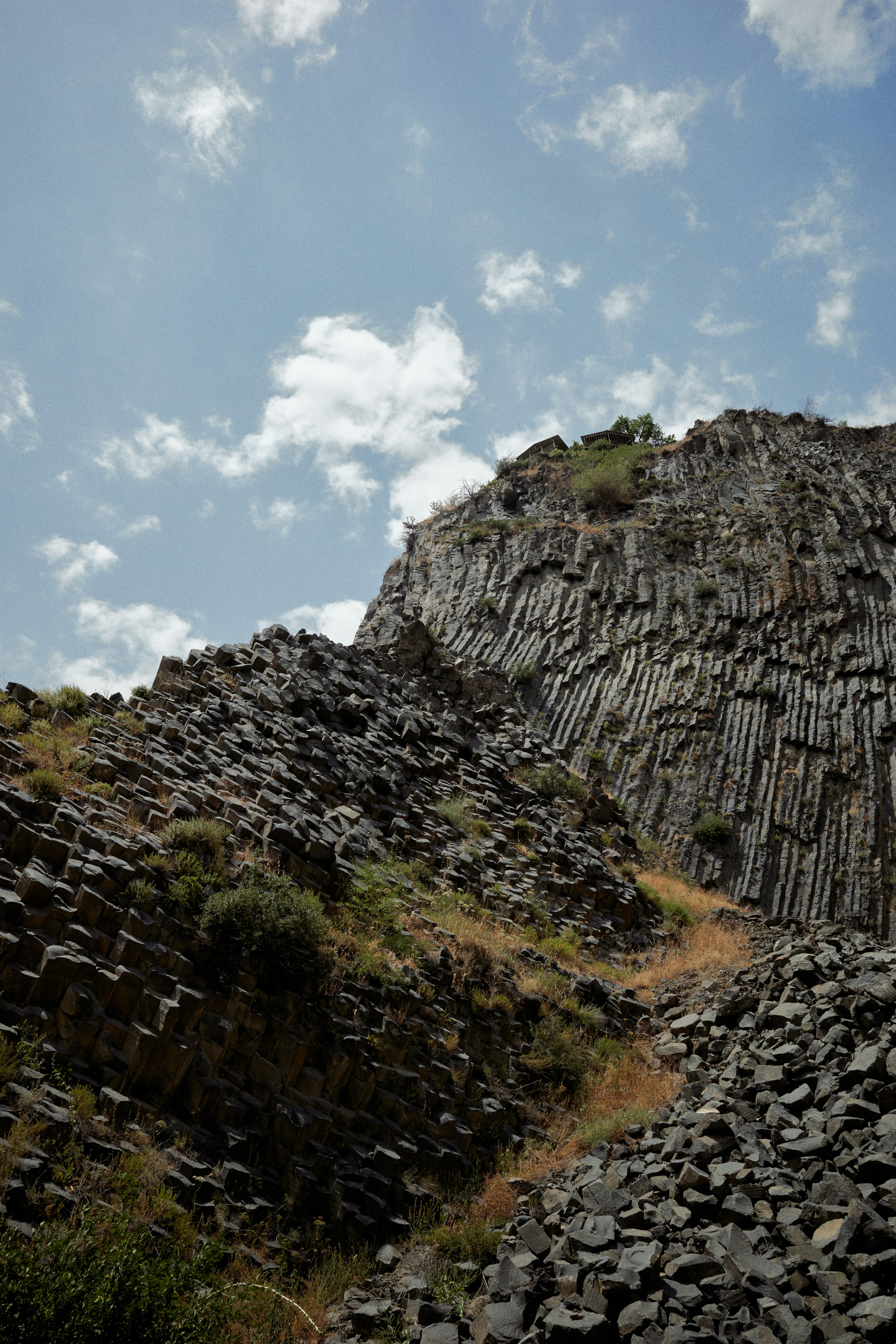 Columnar Basalt Cliff Reaching Toward a Clear Sky