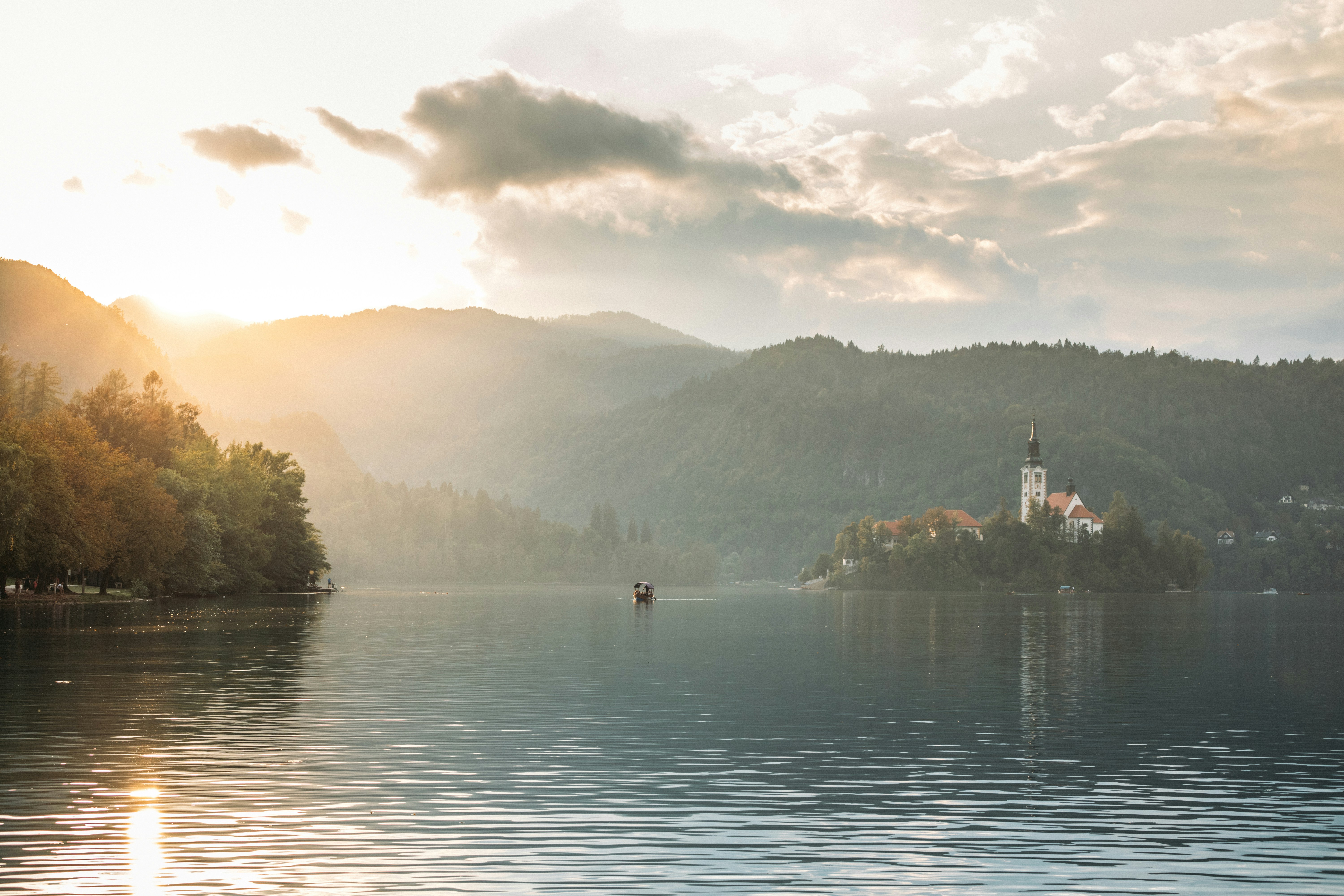 Quiet Lake at Dawn: A Sunlit Path to an Island Church