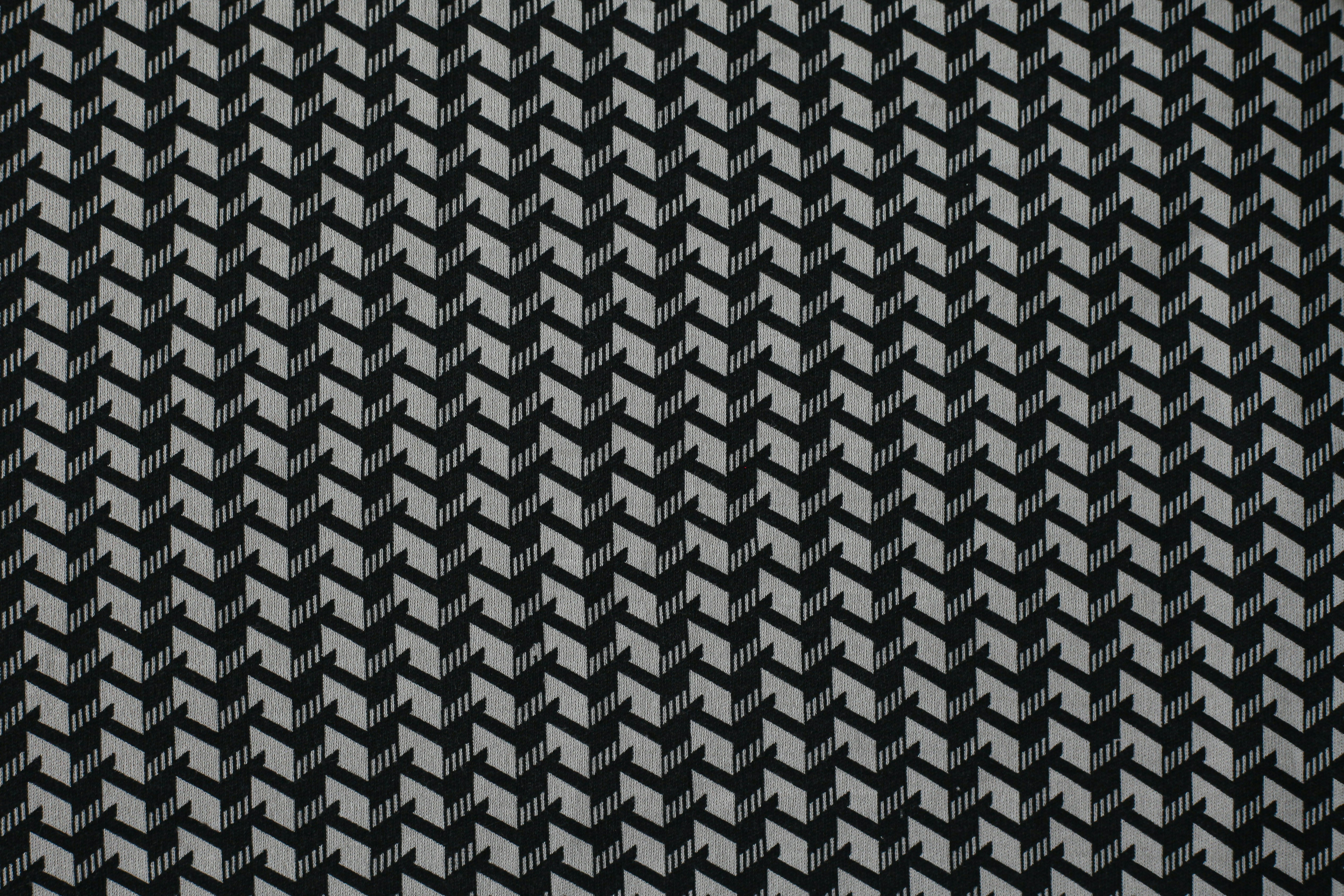 Chevron Echoes: A Tiled Monochrome Pattern with Subtle Depth