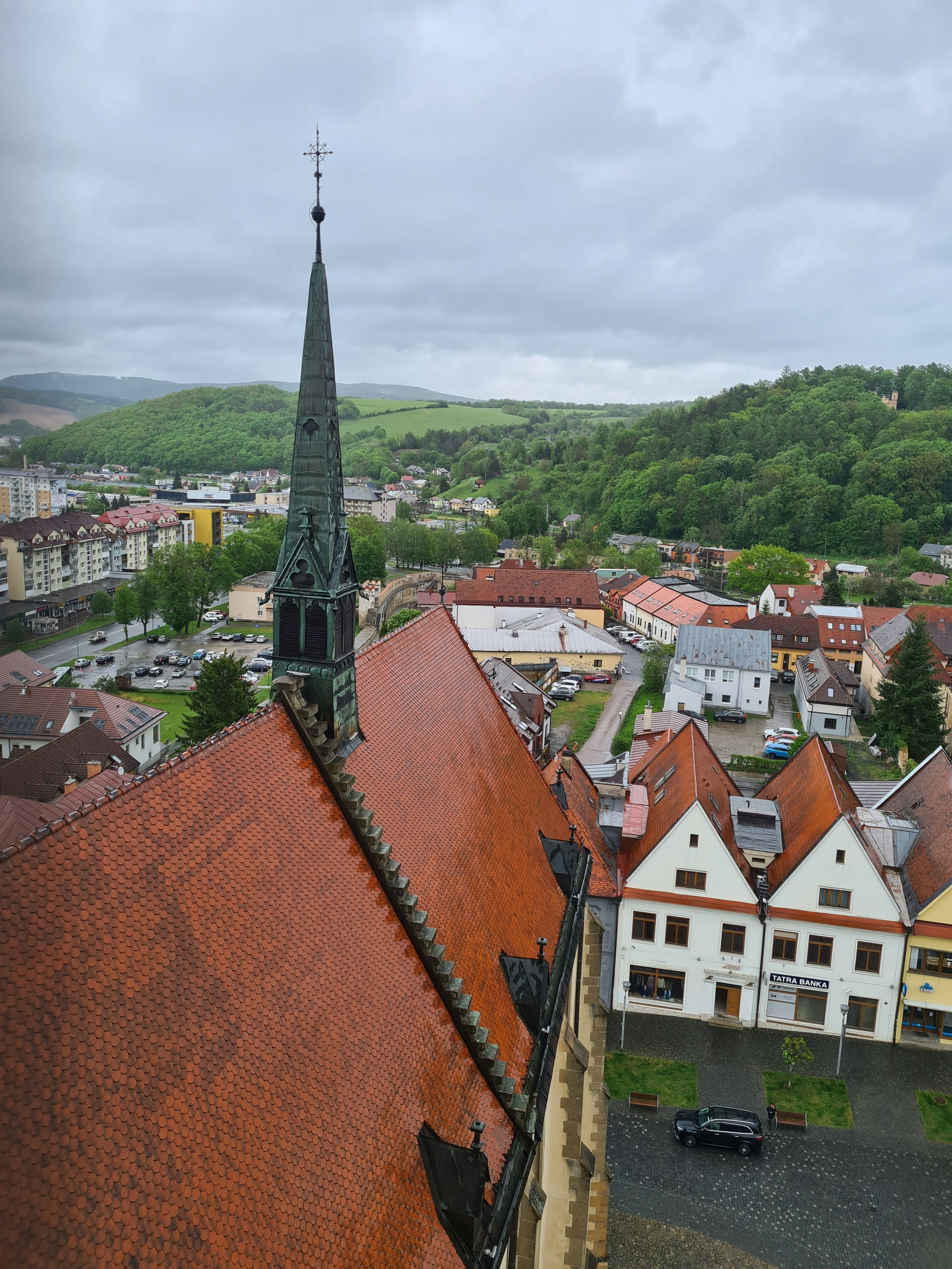 Steeple Over Red-Tiled Village: A Rooftop Perspective