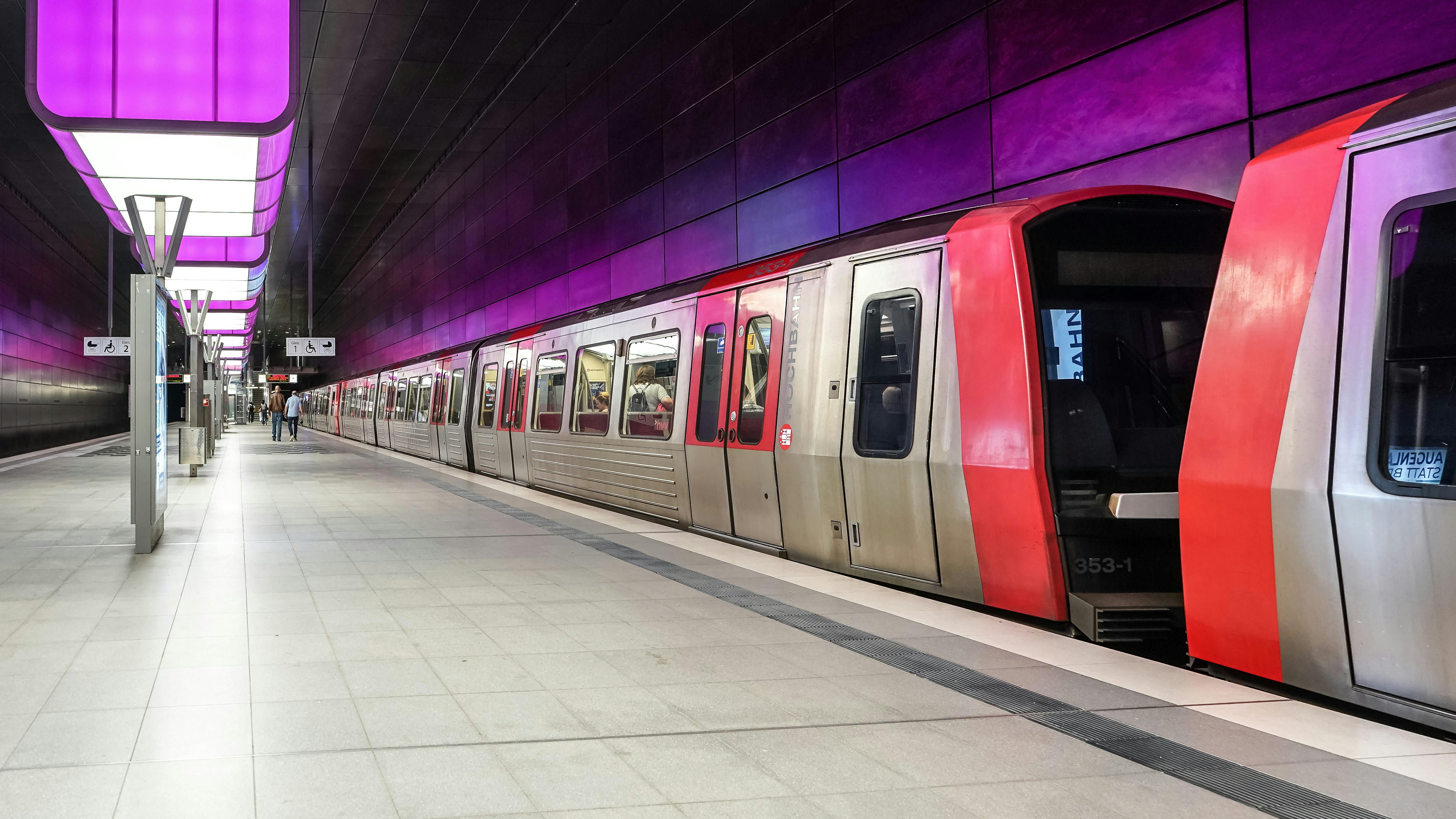 Purple glow and steel echoes: a chrome subway lines up in an empty platform
