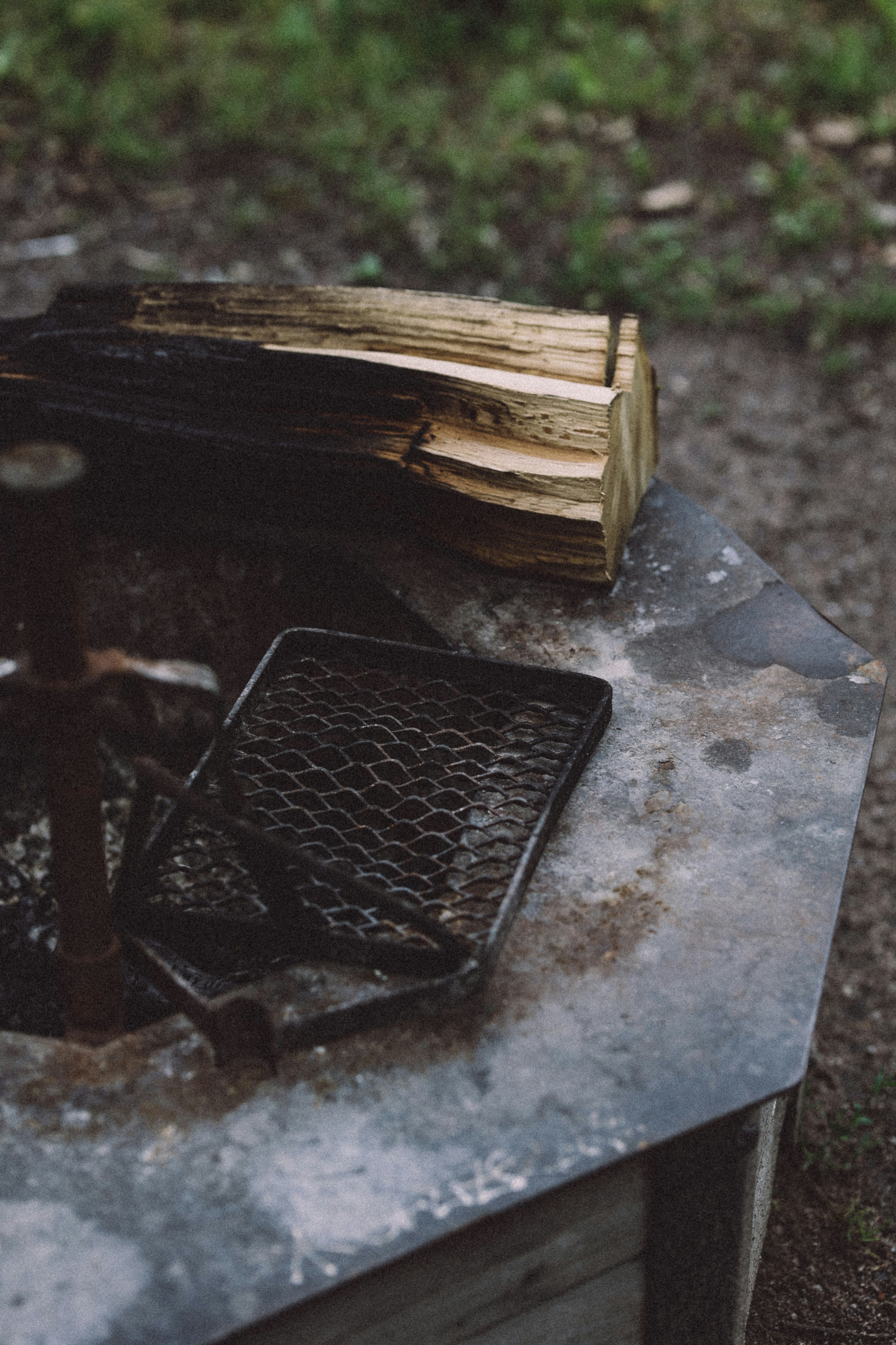 Charred Wood and Charcoal Grid: Fire Pit Quietly Beckons