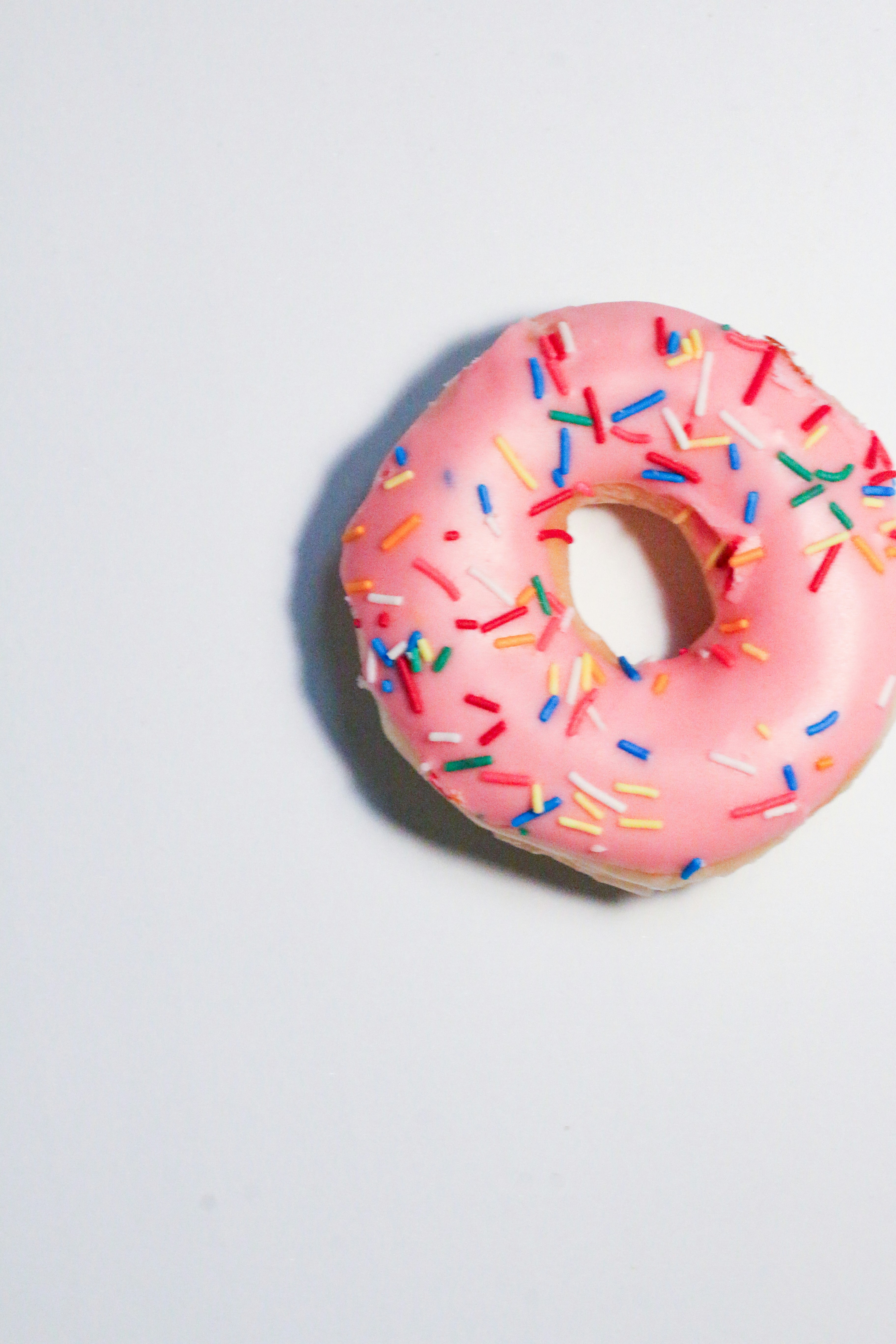 Sugary Focus: A Pink Donut in Minimal Light