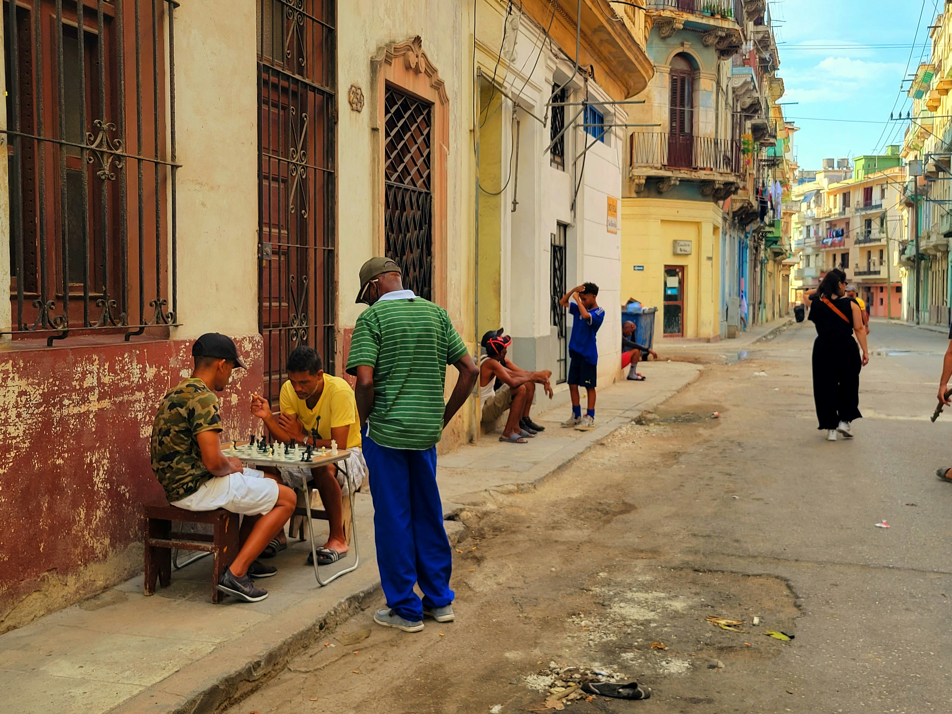 Whispered Games on a Colorful Cuban Street