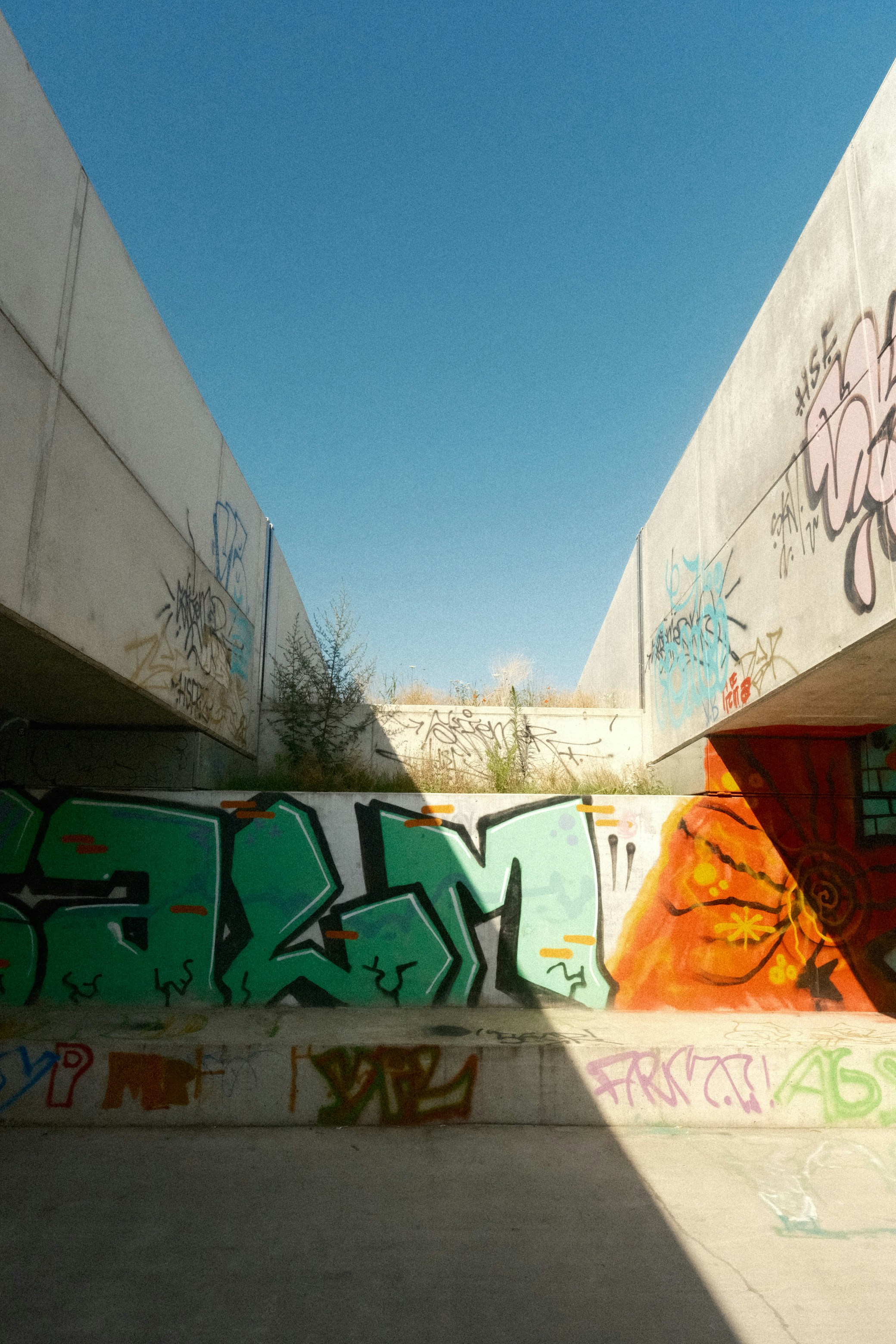 Concrete Canyon of Color: Graffiti Walls Meet Sky