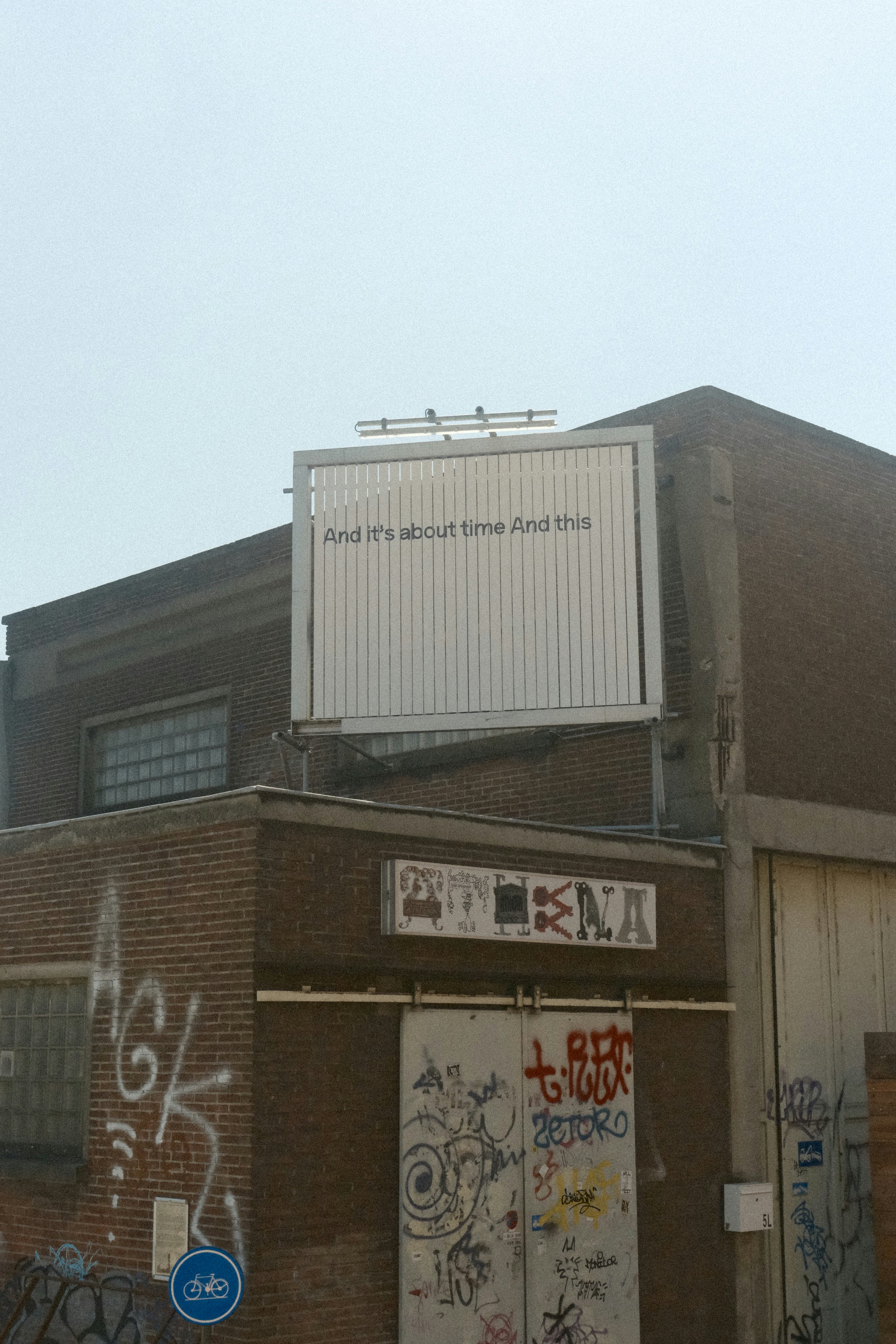 Time’s Reminder on a Graffitied Industrial Facade