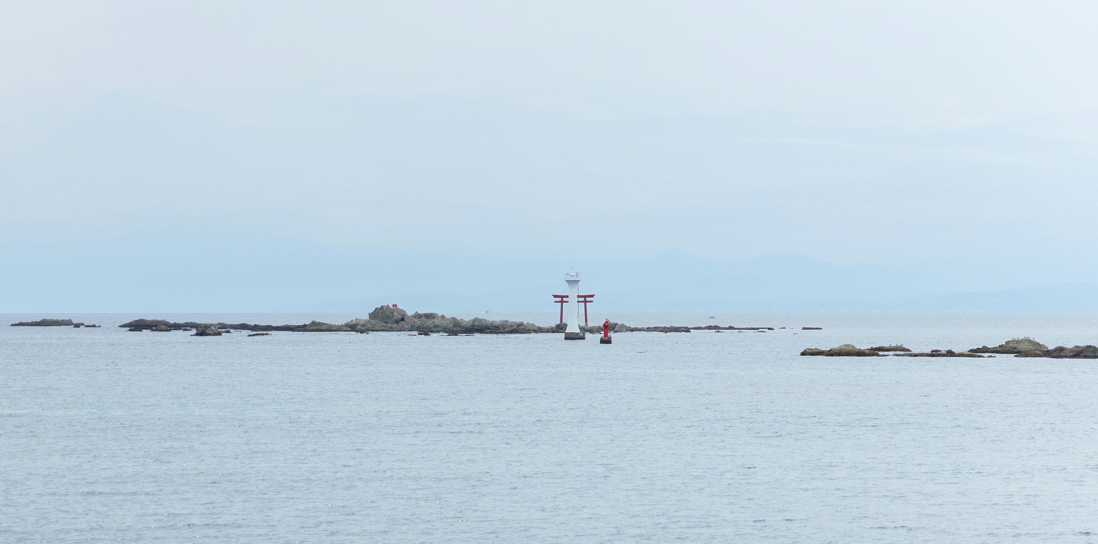 Red Buoy Beacons Over a Quiet Sea