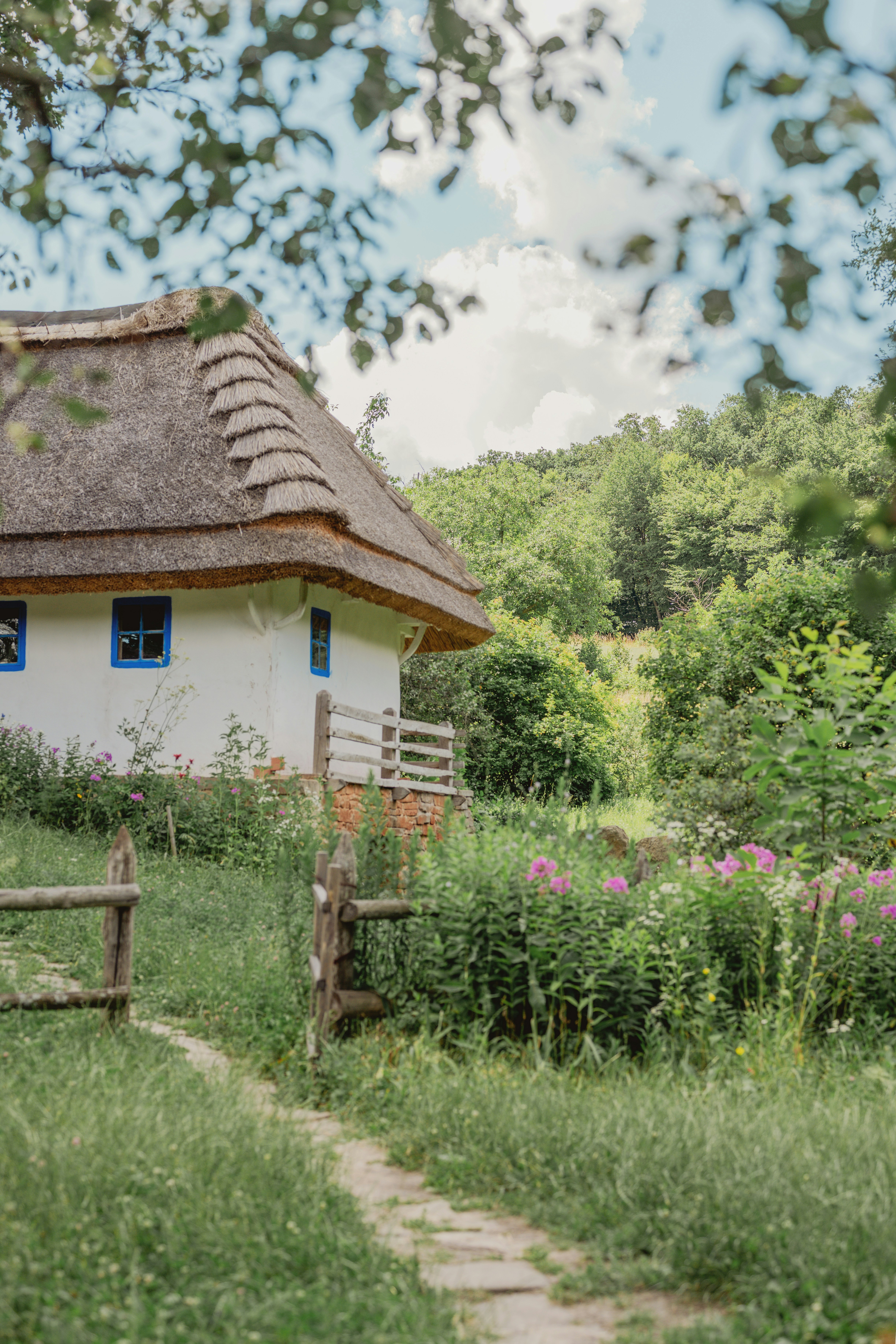 Patch of Blue Roof and White Cottage in a Quiet Meadow