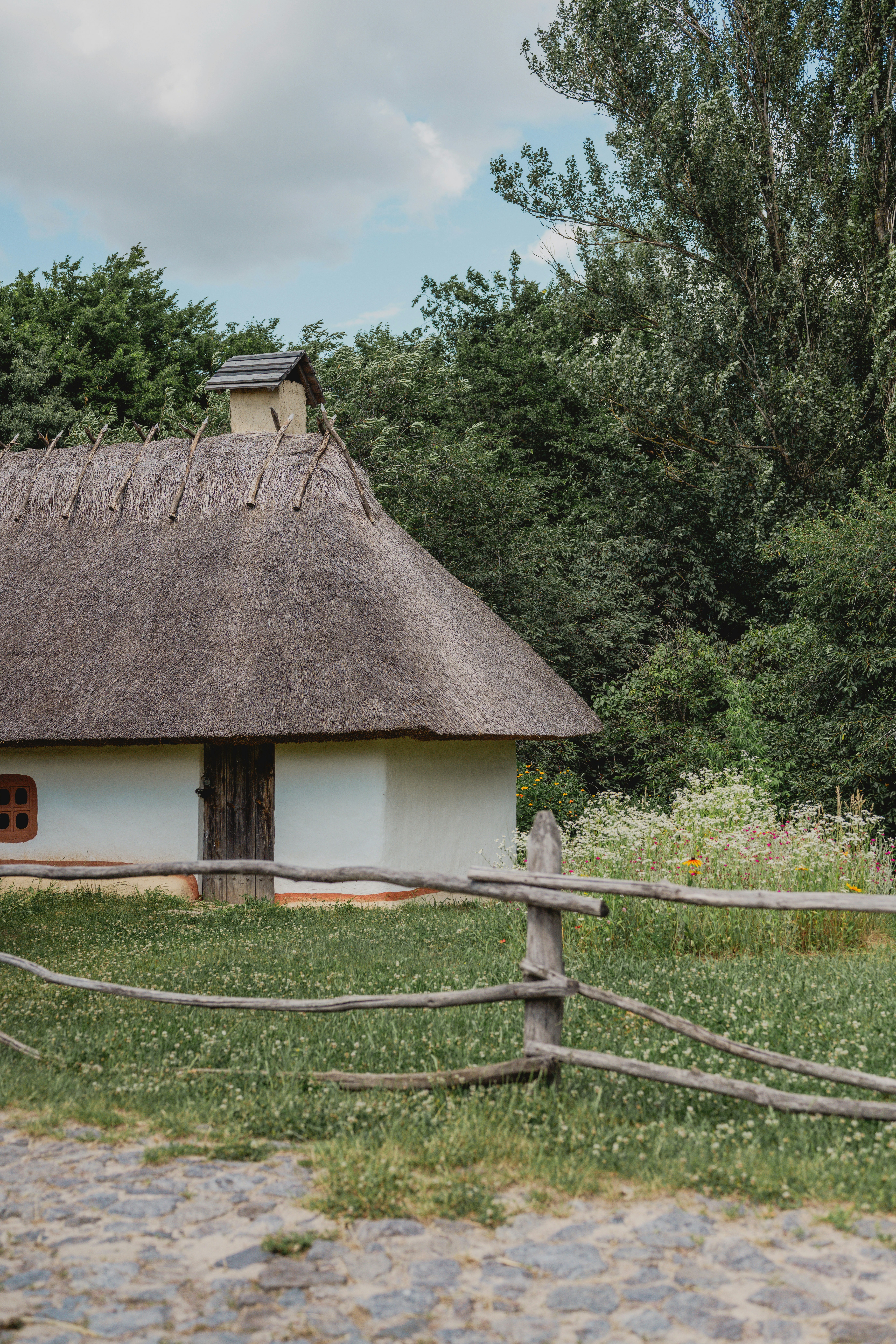Thatched Cottage Under a Sunlit Sky