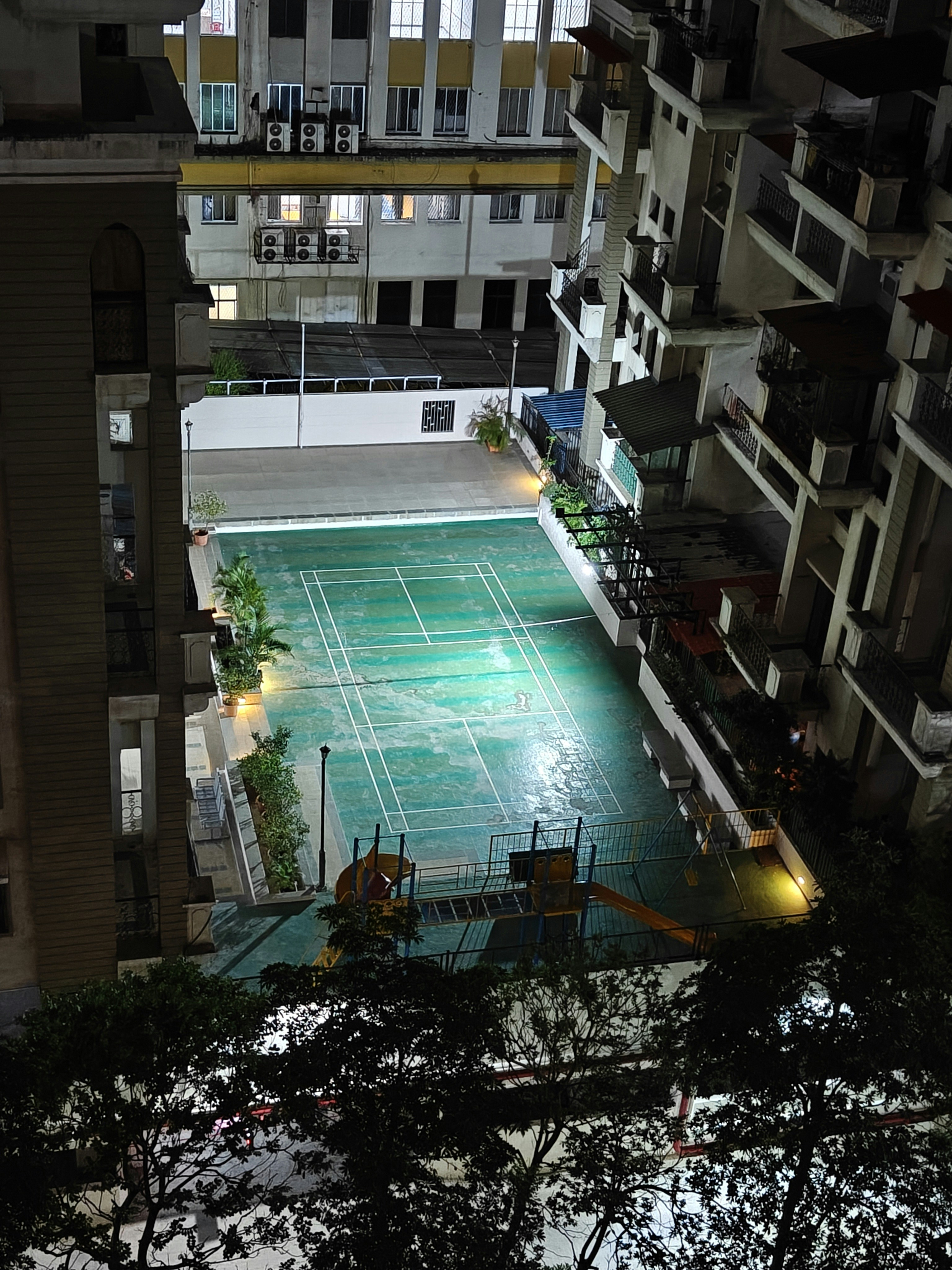 Night Court: A Quiet Tennis Court Nestled Between Urban Towers