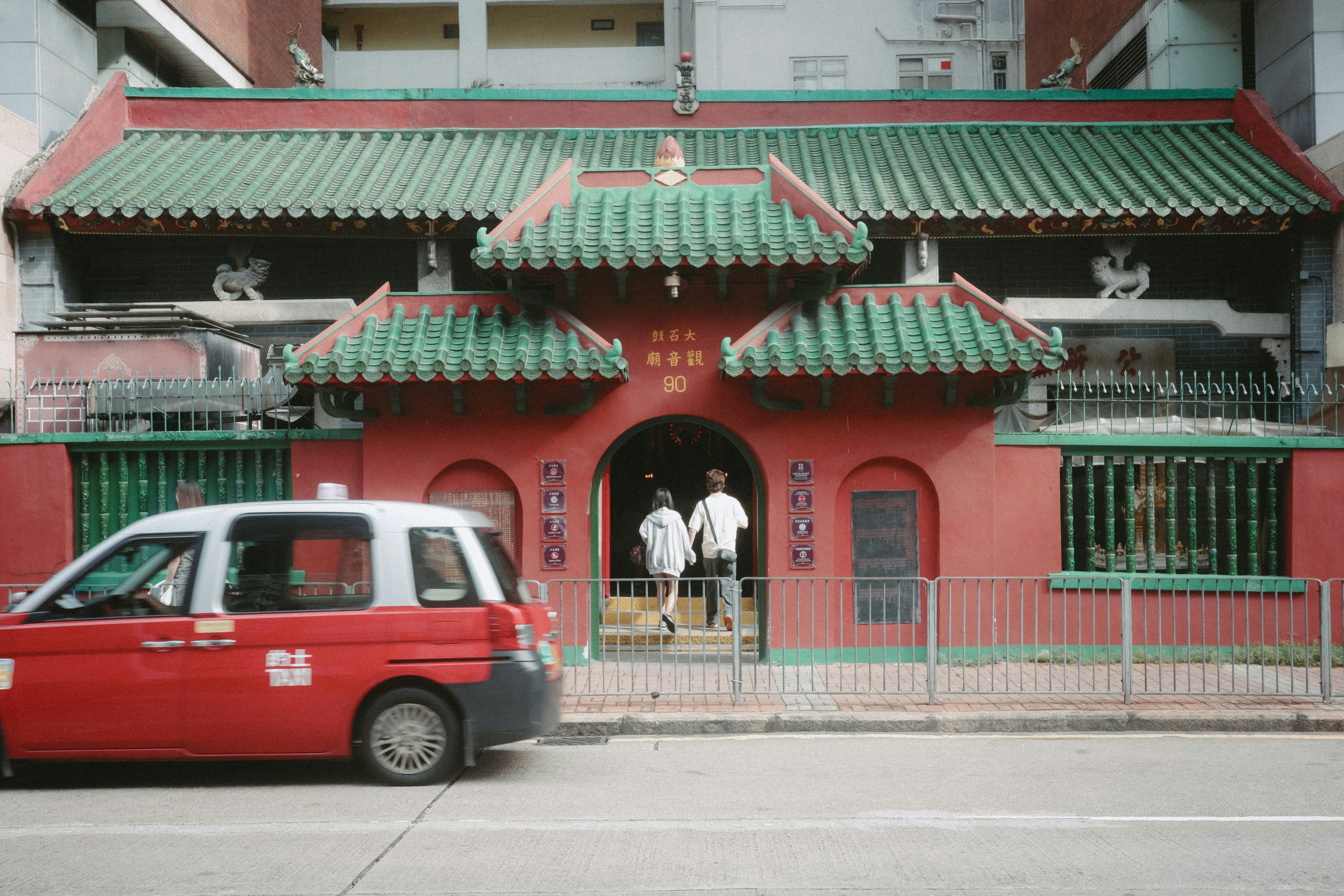 Red Taxi, Green Roofs: A Moment at a Chinese Temple Gate