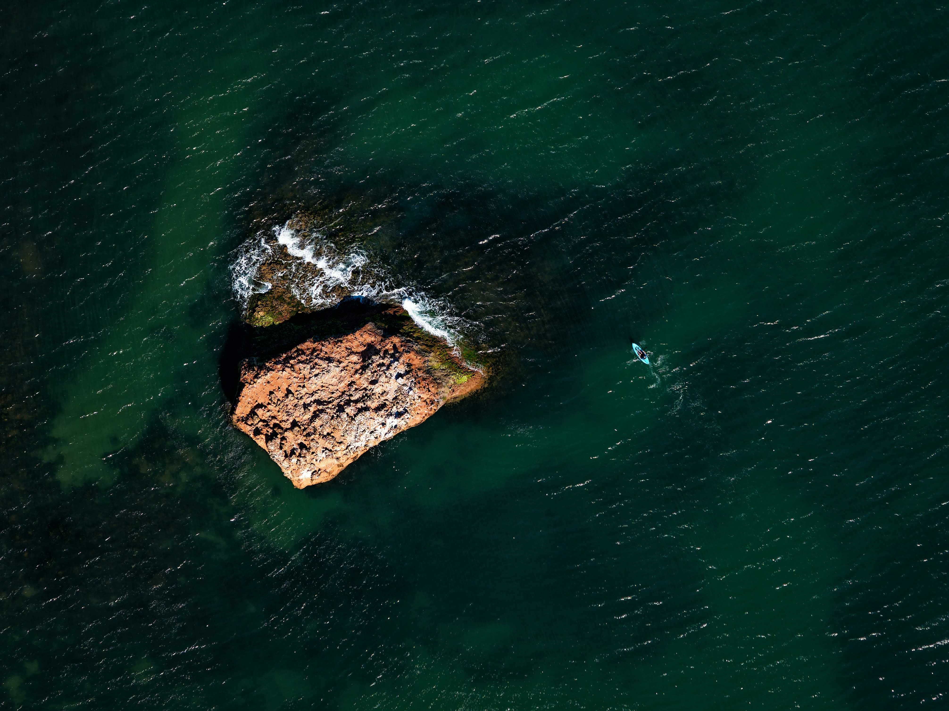 Isolated Granite Sentinel Beneath Turquoise Seas