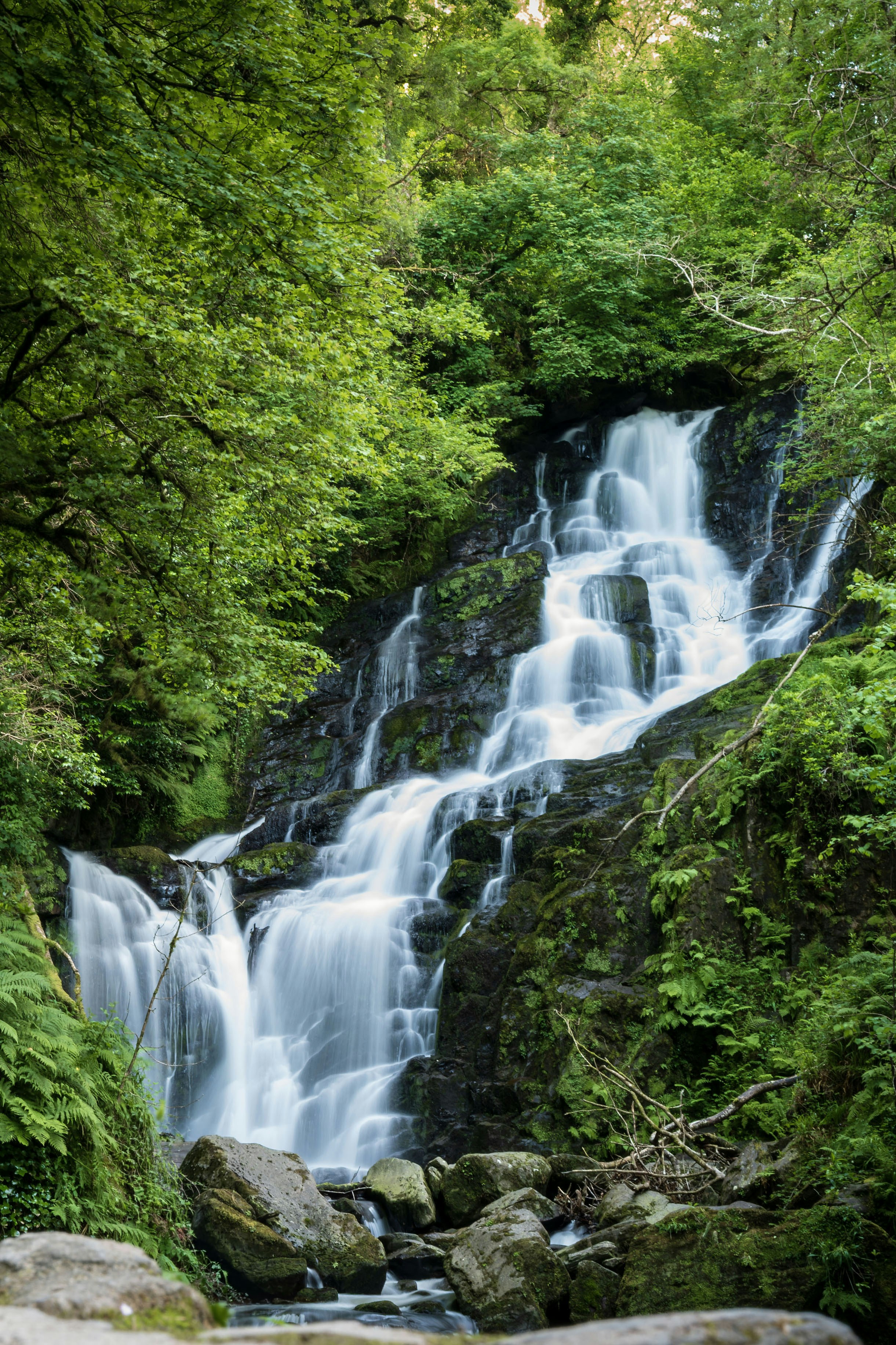 Torc Waterfall is a 20 metres high, 110 metres long cascade waterfall formed by the Owengarriff River as it drains from the Devil's Punchbowl corrie lake at Mangerton Mountain. The waterfall, which lies at the base of Torc Mountain, in the Killarney National Park.