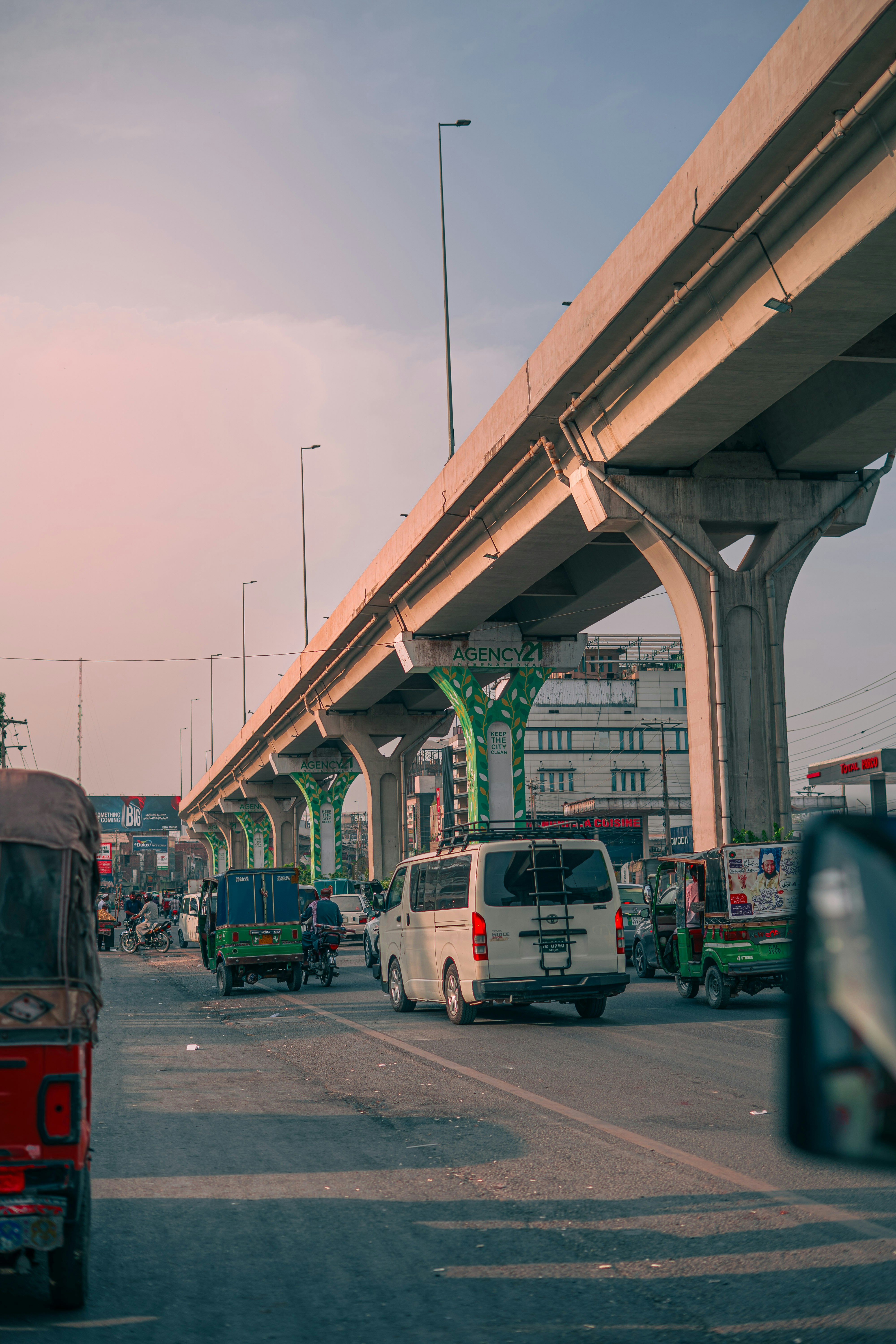 Concrete Arches Over a Busy Bangkok-like Avenue at Golden Hour