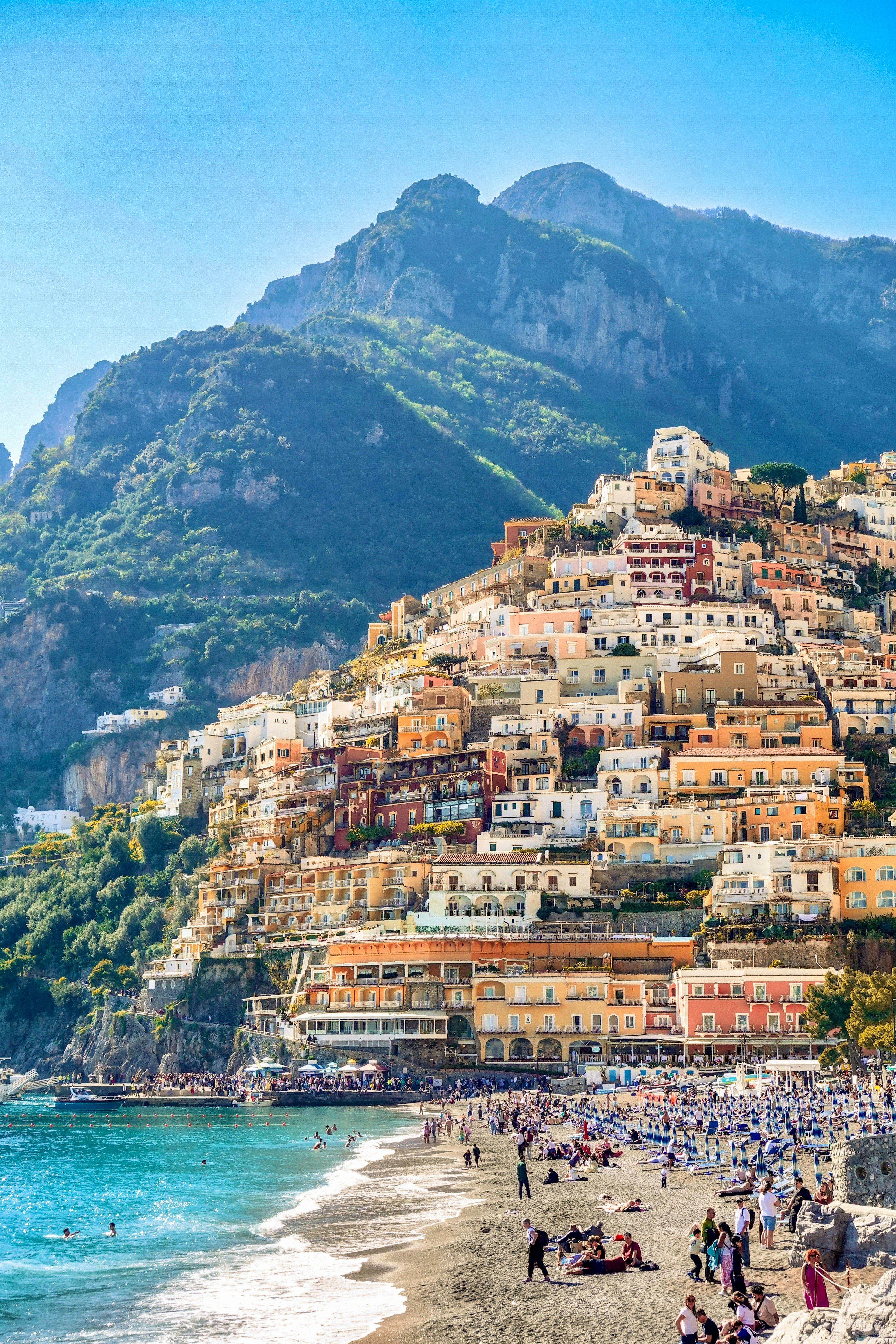 Colorful hillside village spilling into a sunlit Adriatic shore