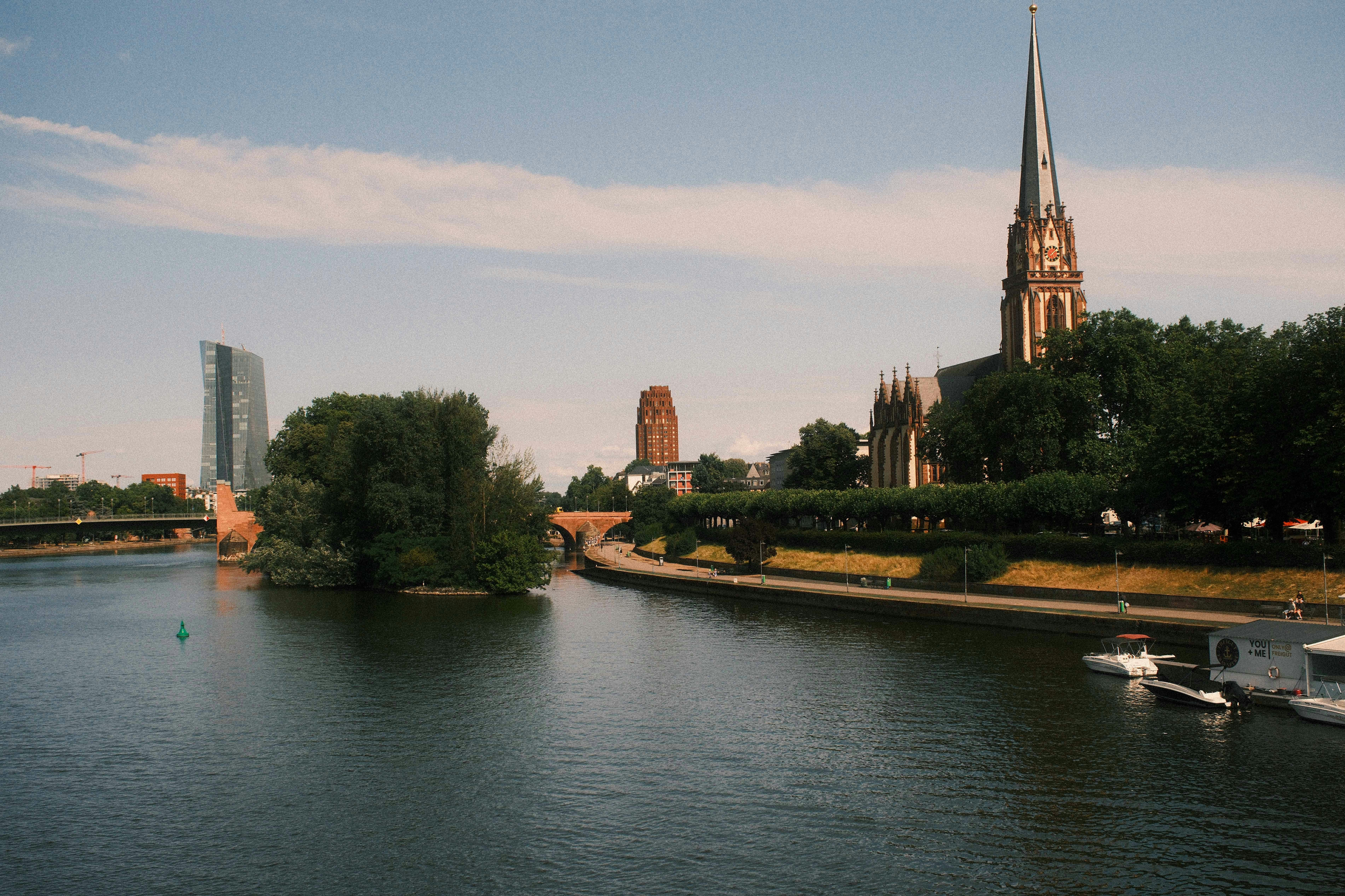 Riverside Gothic Spire: Cityscape Over Calm Water