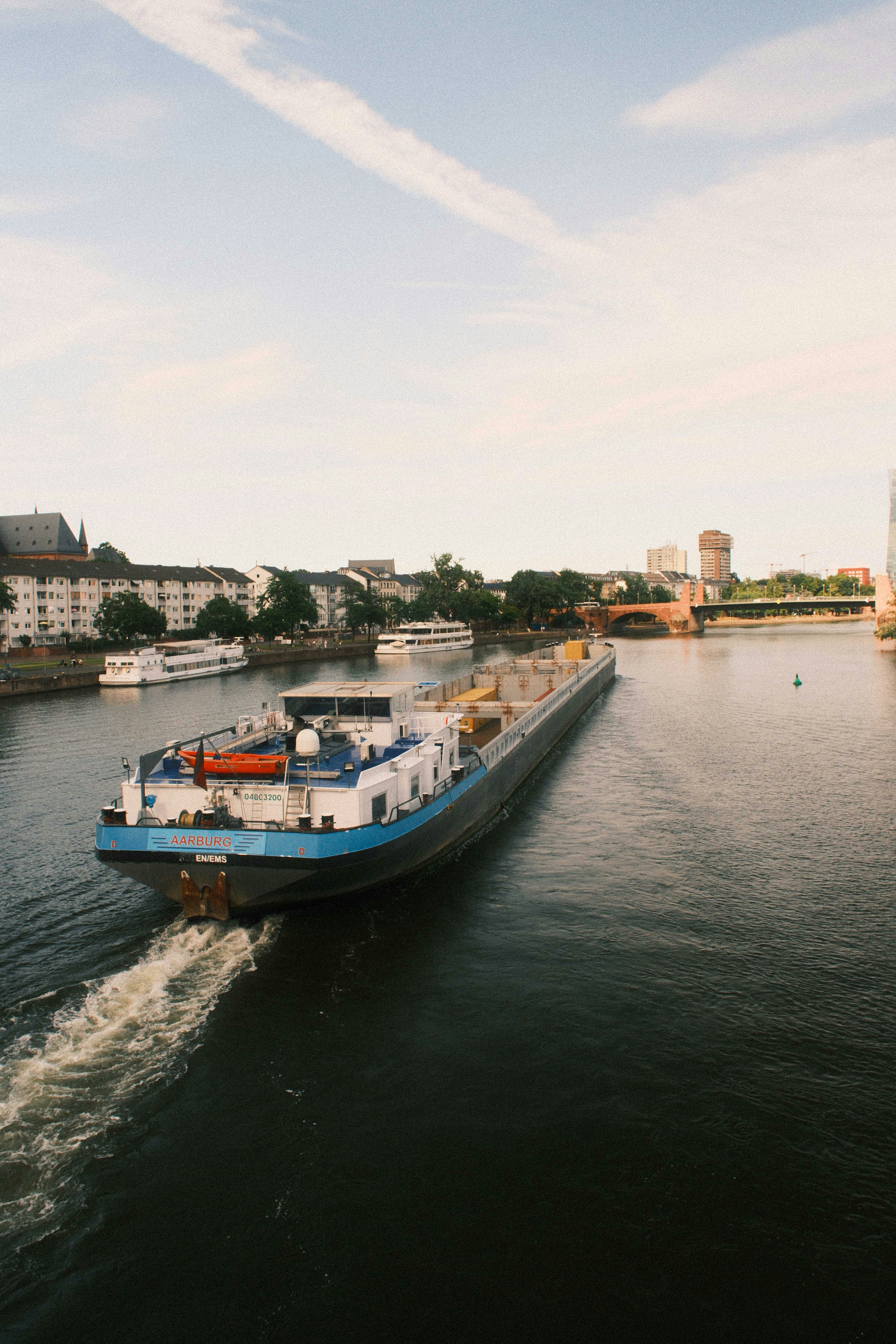 Blue-hulled Freight Hopper Roving the Rhine at Dawn