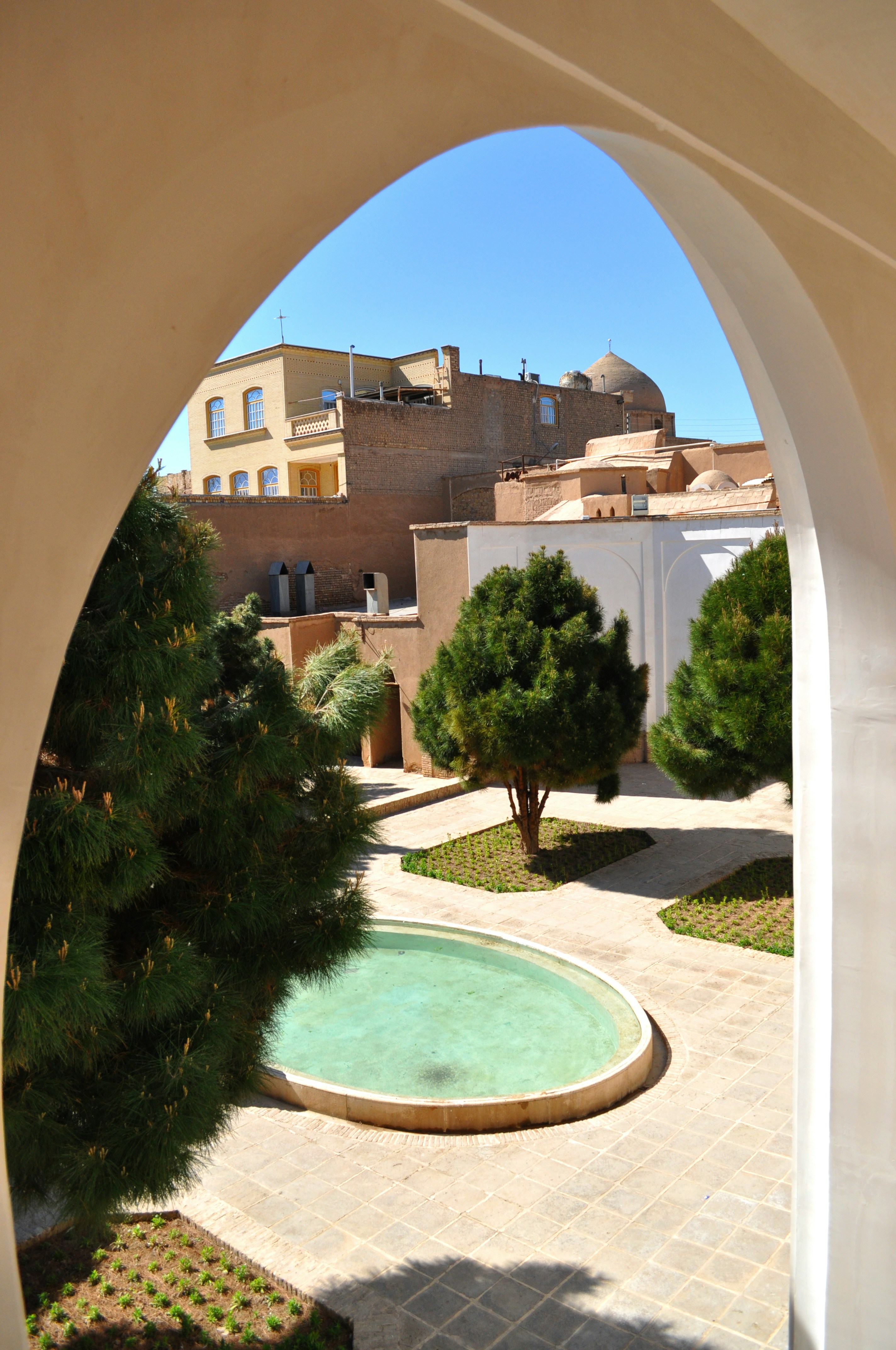 Archway to Courtyard: A Sunlit Oasis Framed by Desert Architecture