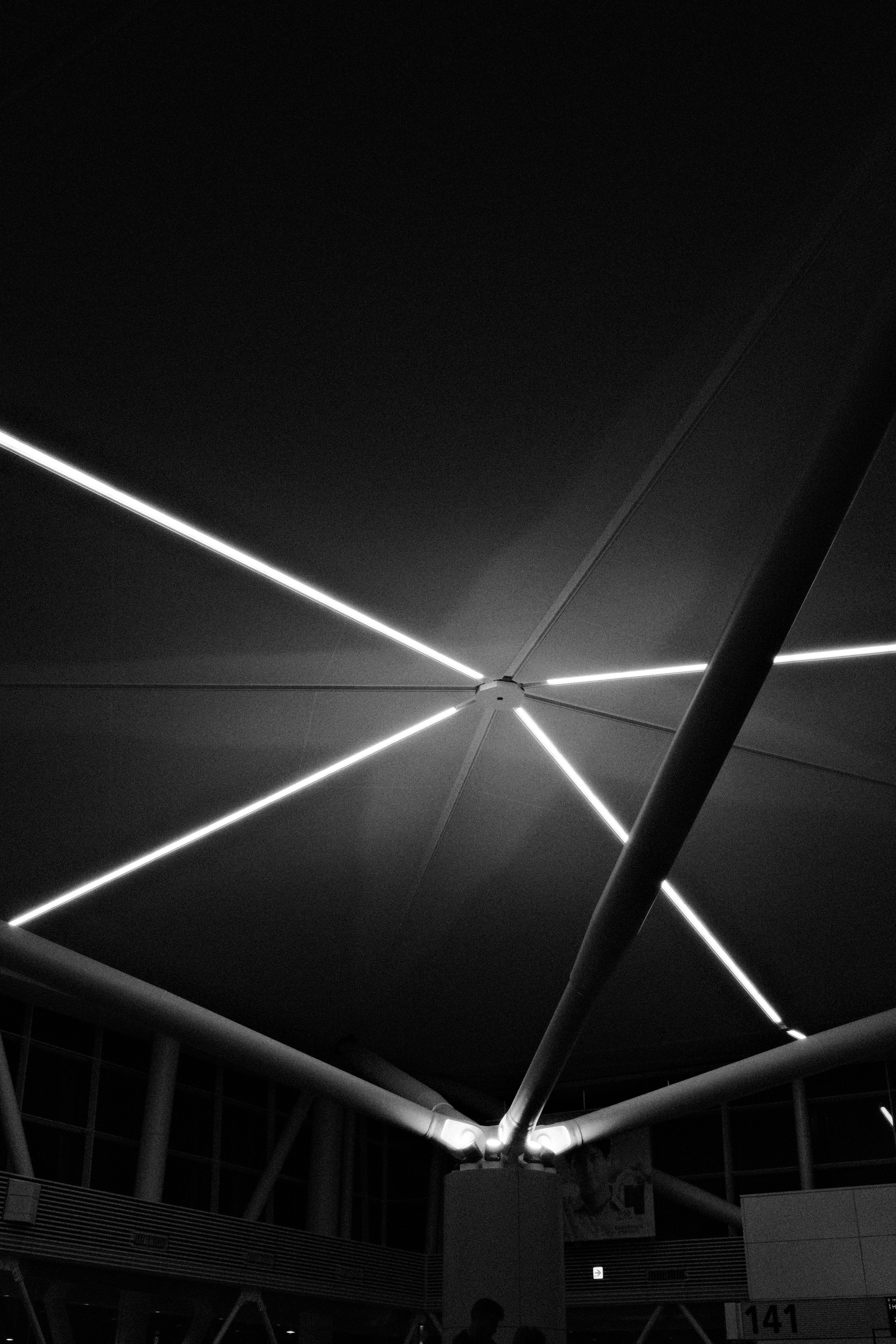 Glowing Tension: Neon Lines Converge Over a Structural Dome