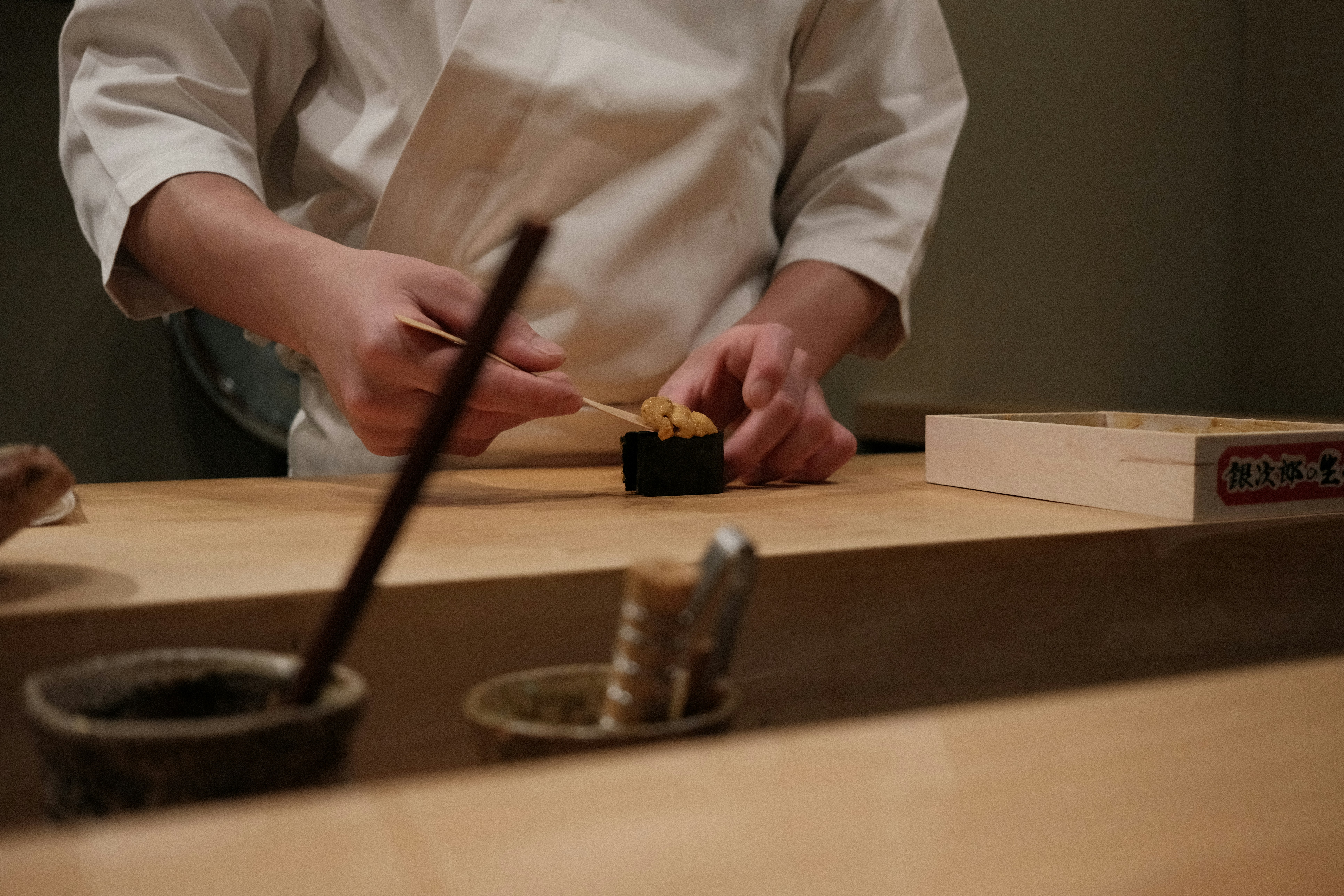 Sushi Chef's Subtle Craft in Soft Kitchen Light