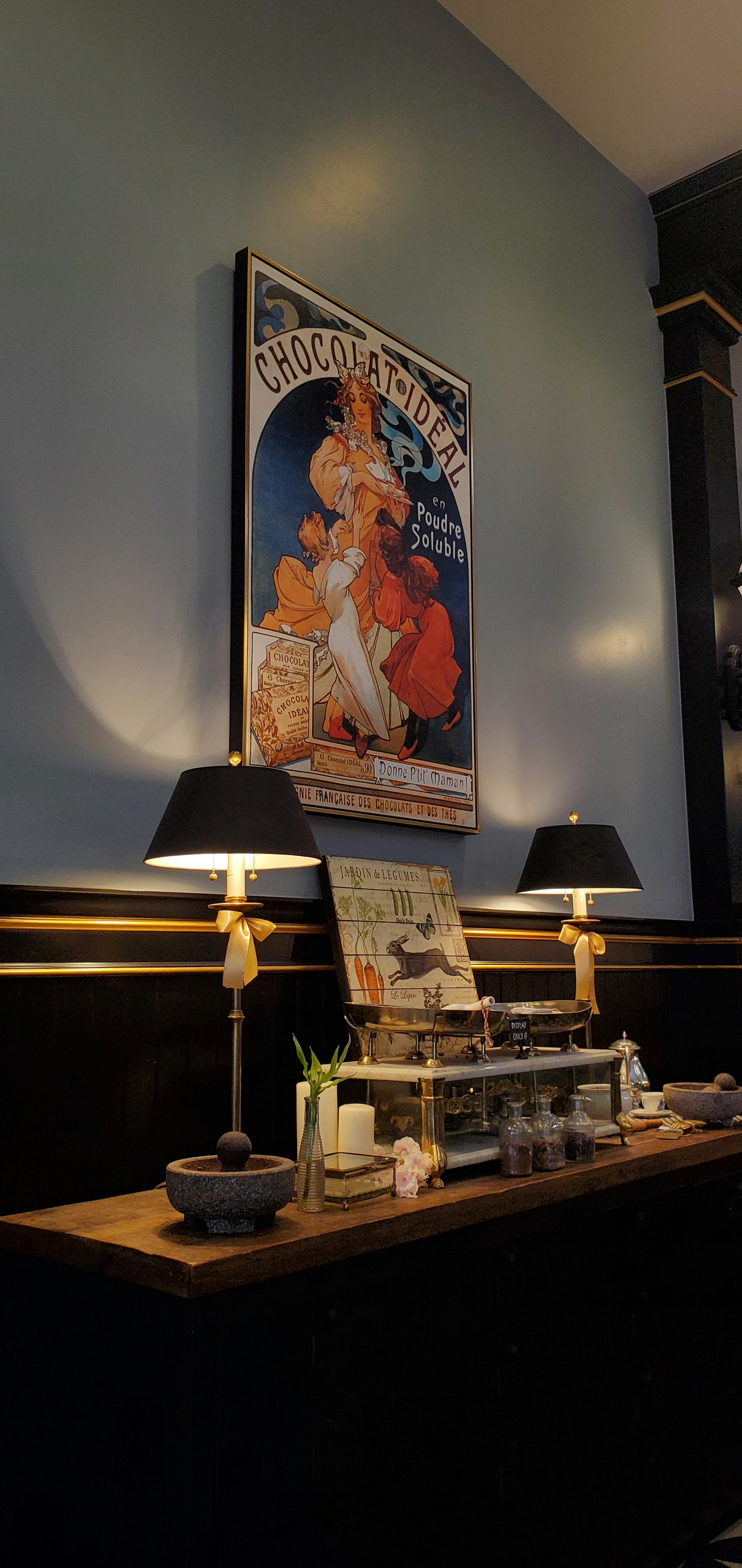 Elegant tea-lit keepsake: a vintage poster watches over a refined service station