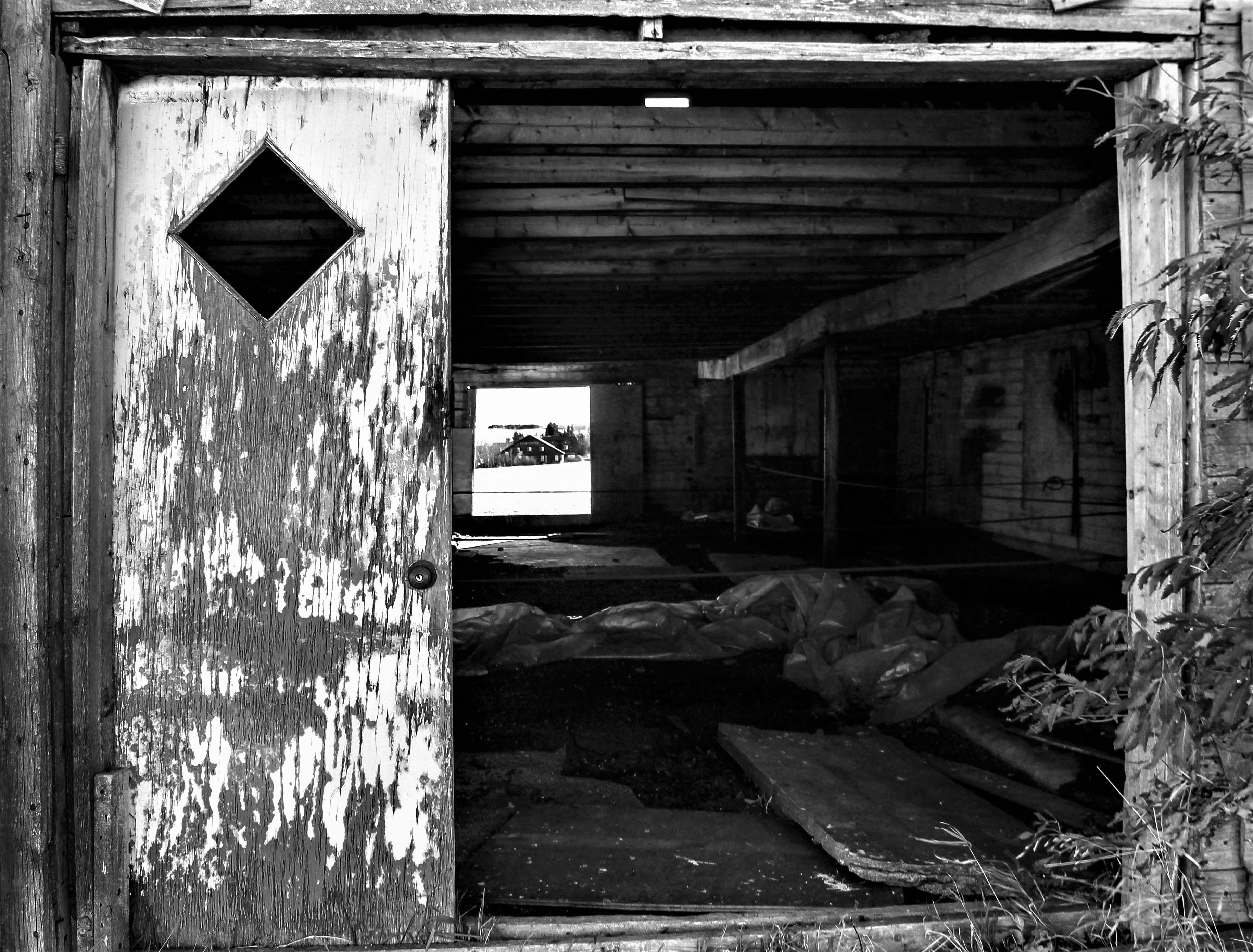 Abandoned Open Doorway: Light at the End of a Crumbling Barn