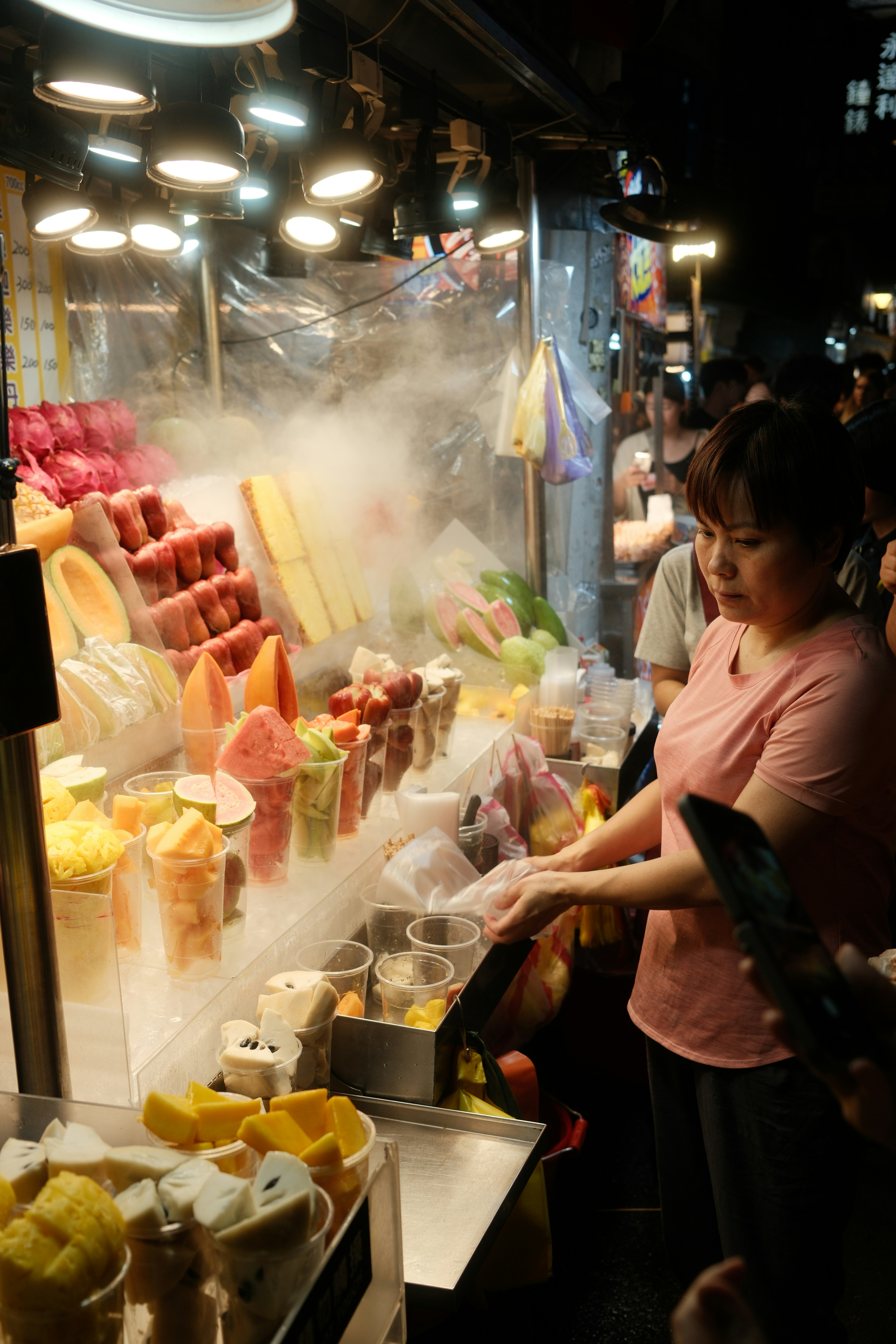 Steam and Sugar: A Market Vendor in Warm Night Light