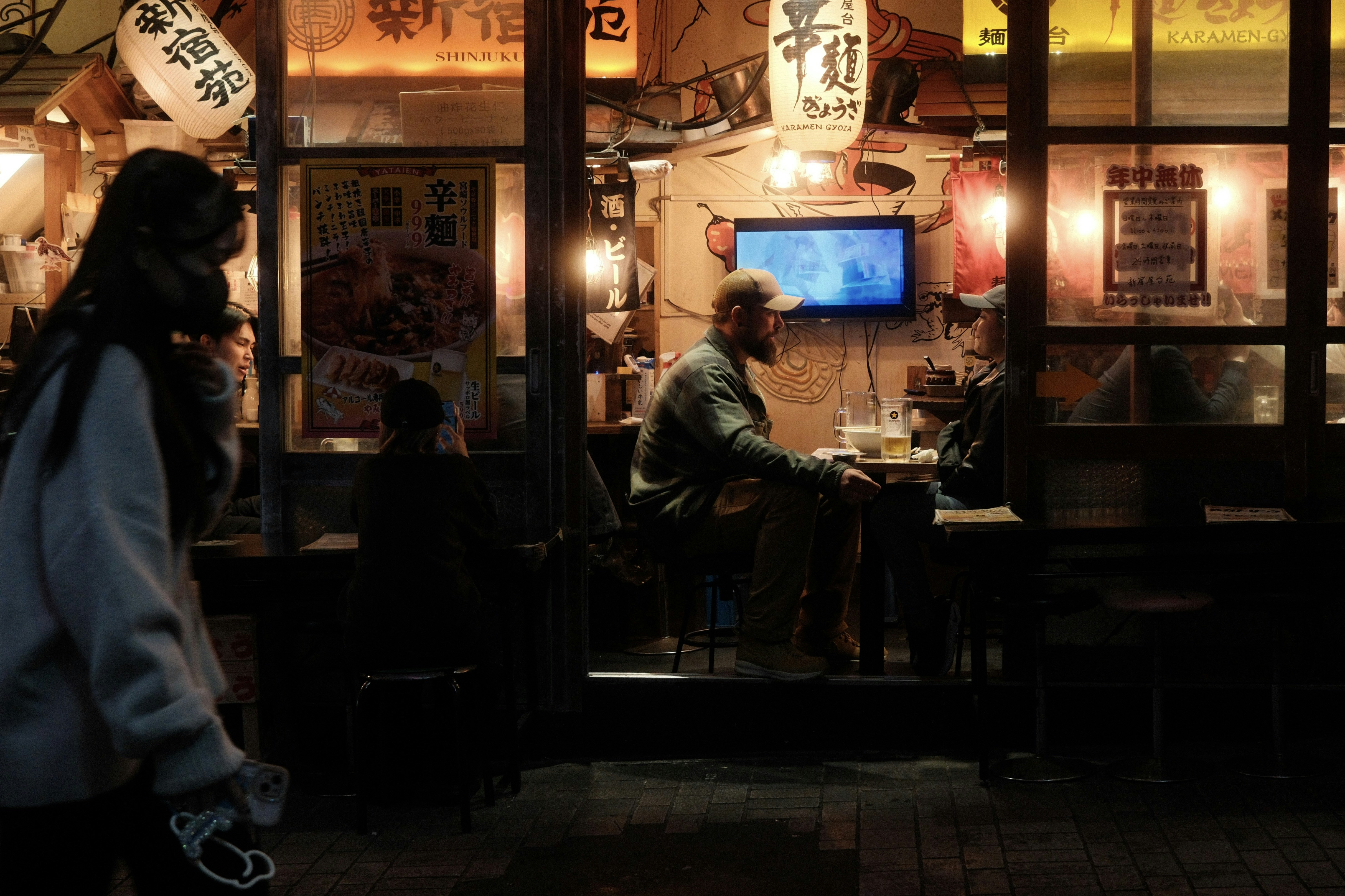 Neon-lit Noodle Bar: Quiet Front Table Under Lanterns
