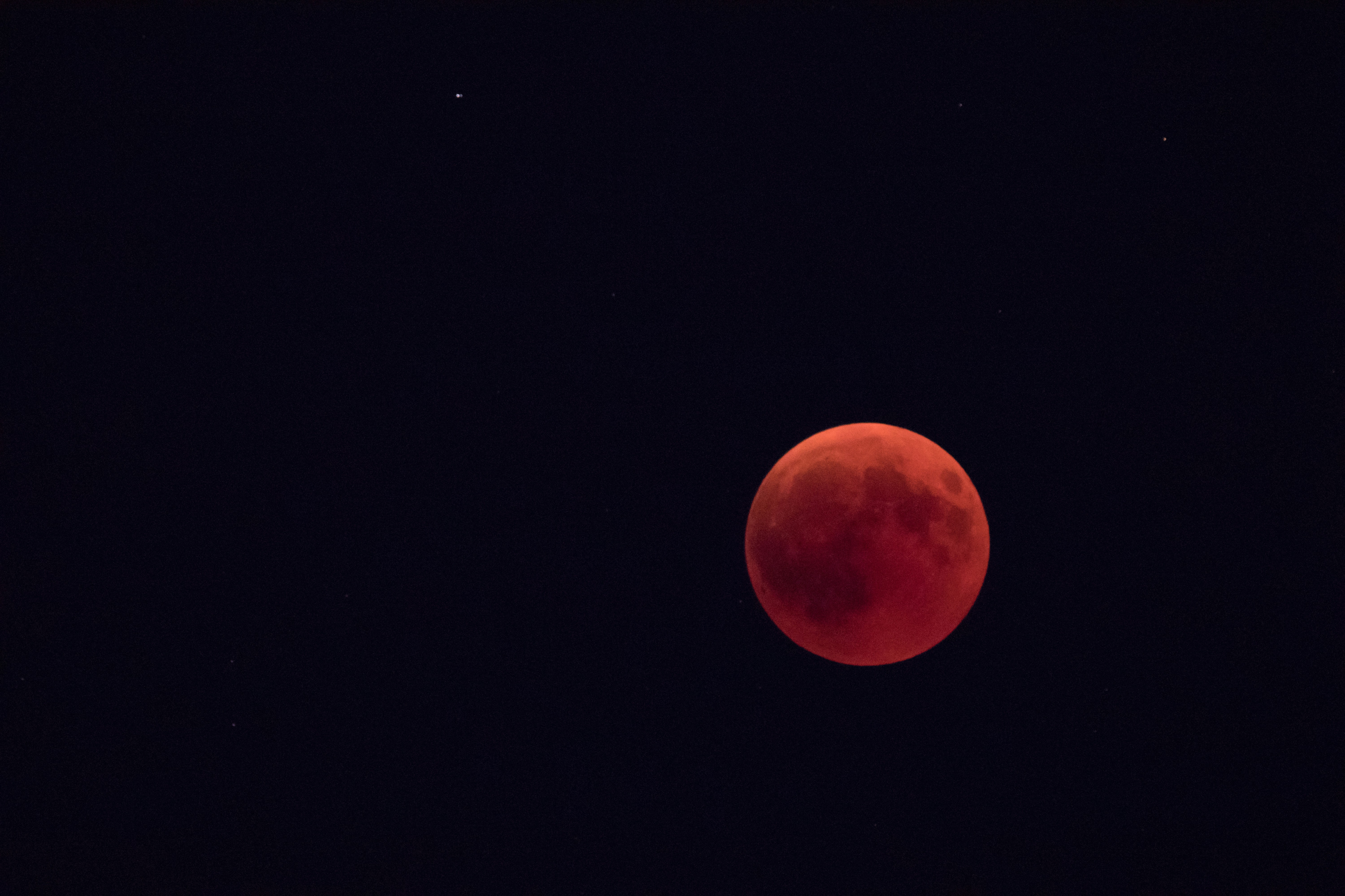 Crimson Lunar Glow: A quiet lunar eclipse over a dark canvas