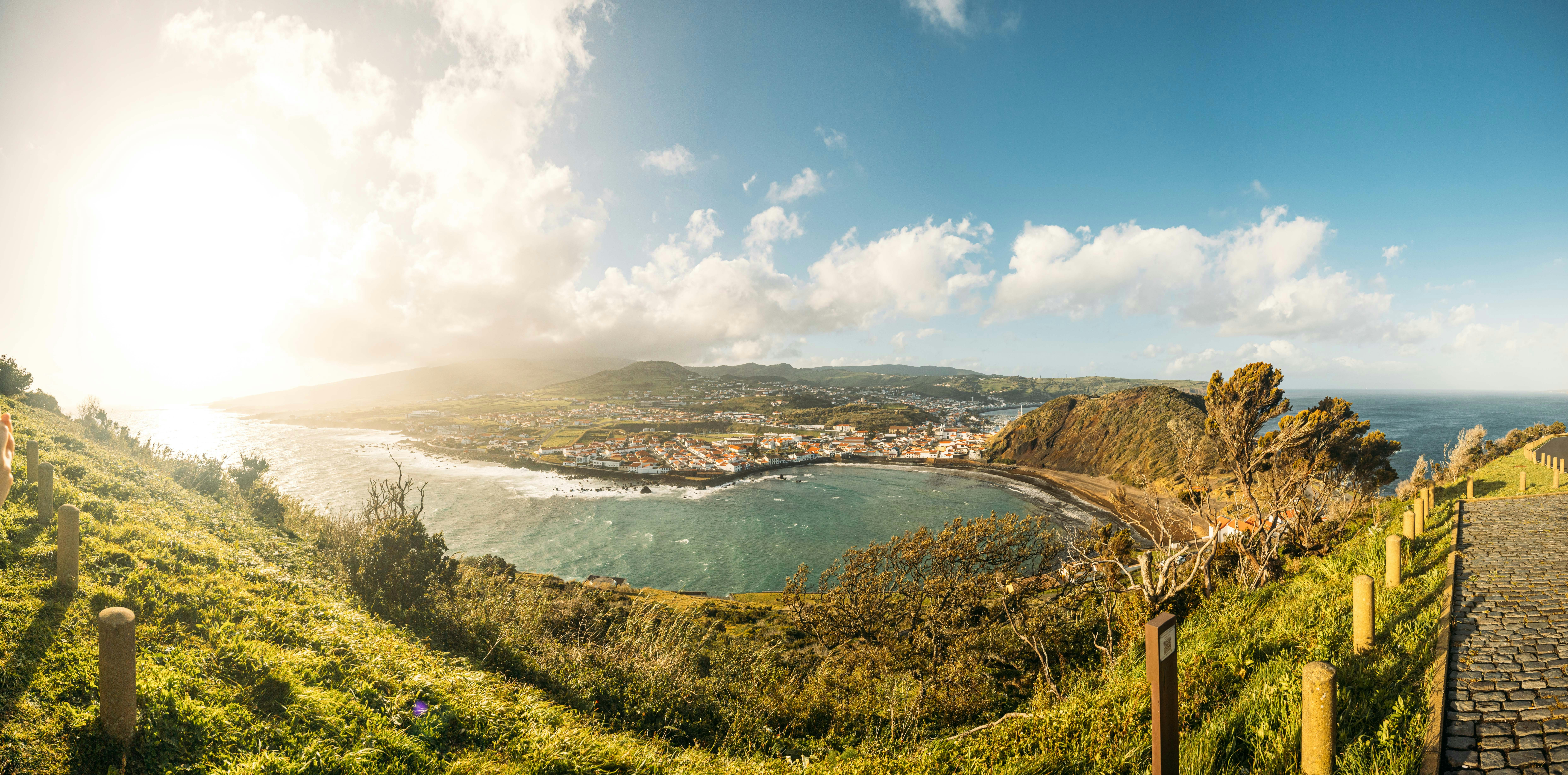 Golden Haven: Panoramic Coastal Ridge Overlooking a Sunny Bay