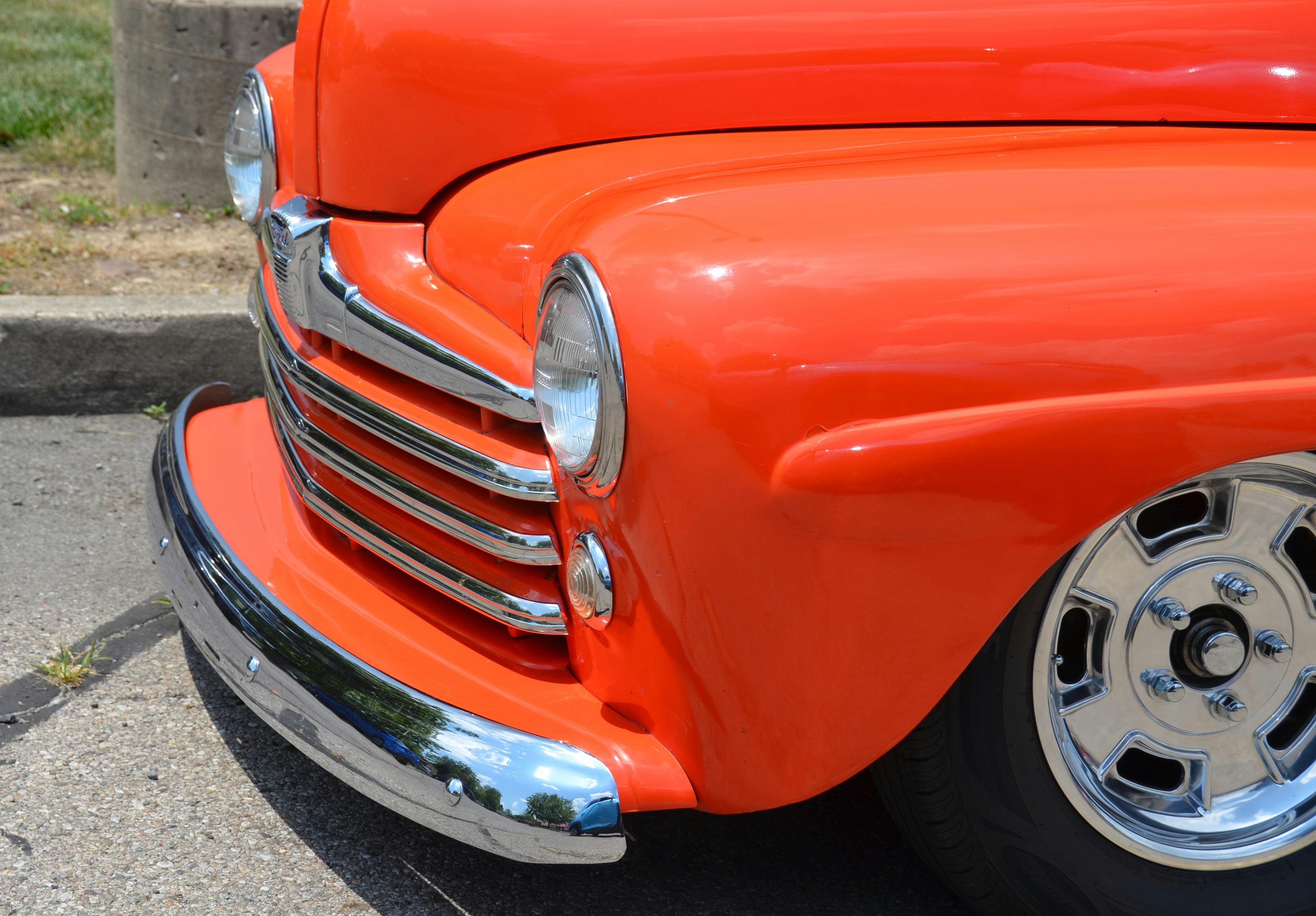 Chrome Reflections: The Front Quarter of a Bright Orange Classic