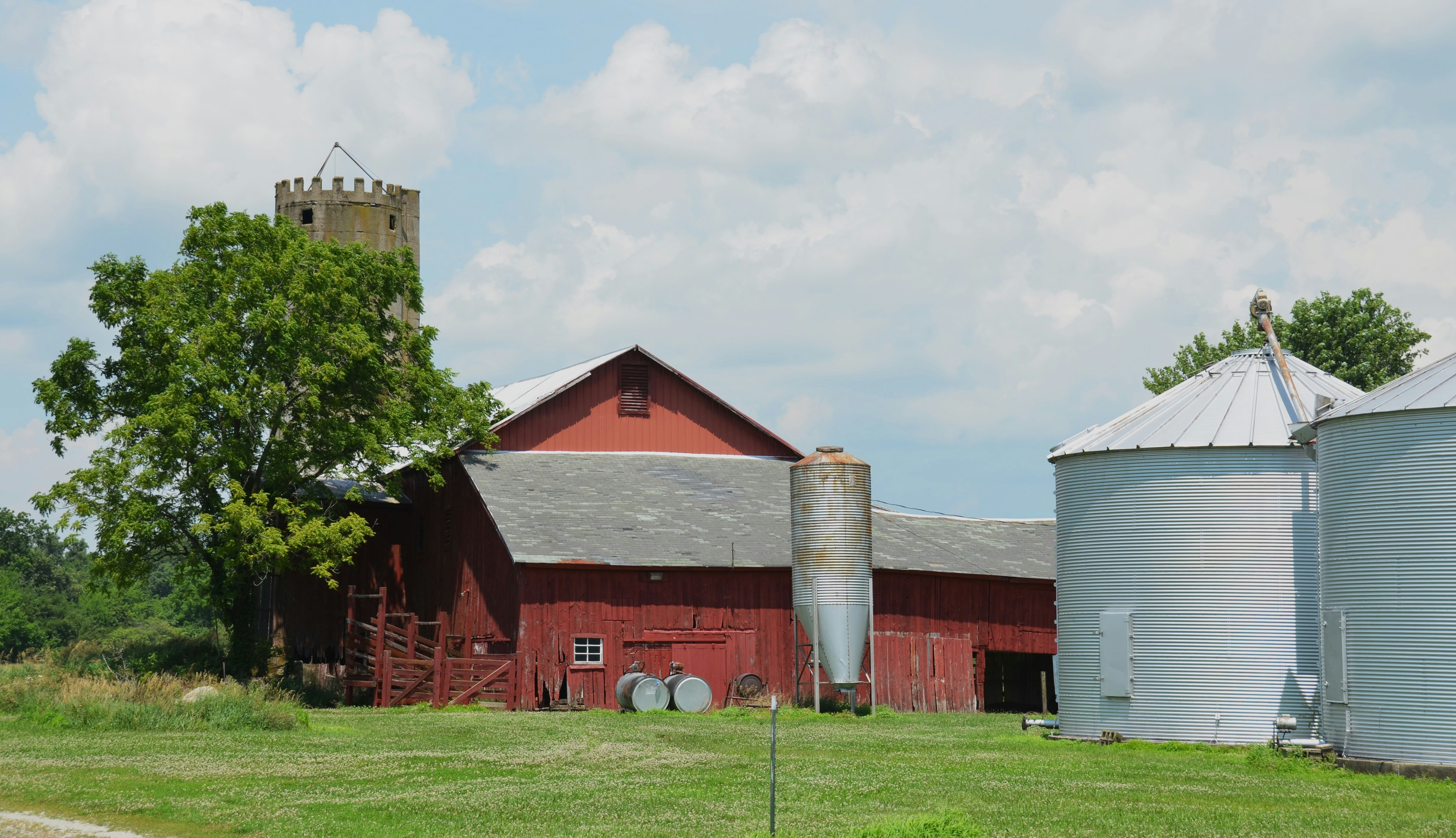Red Barn and Grain Silos Under a Bright Rural Sky