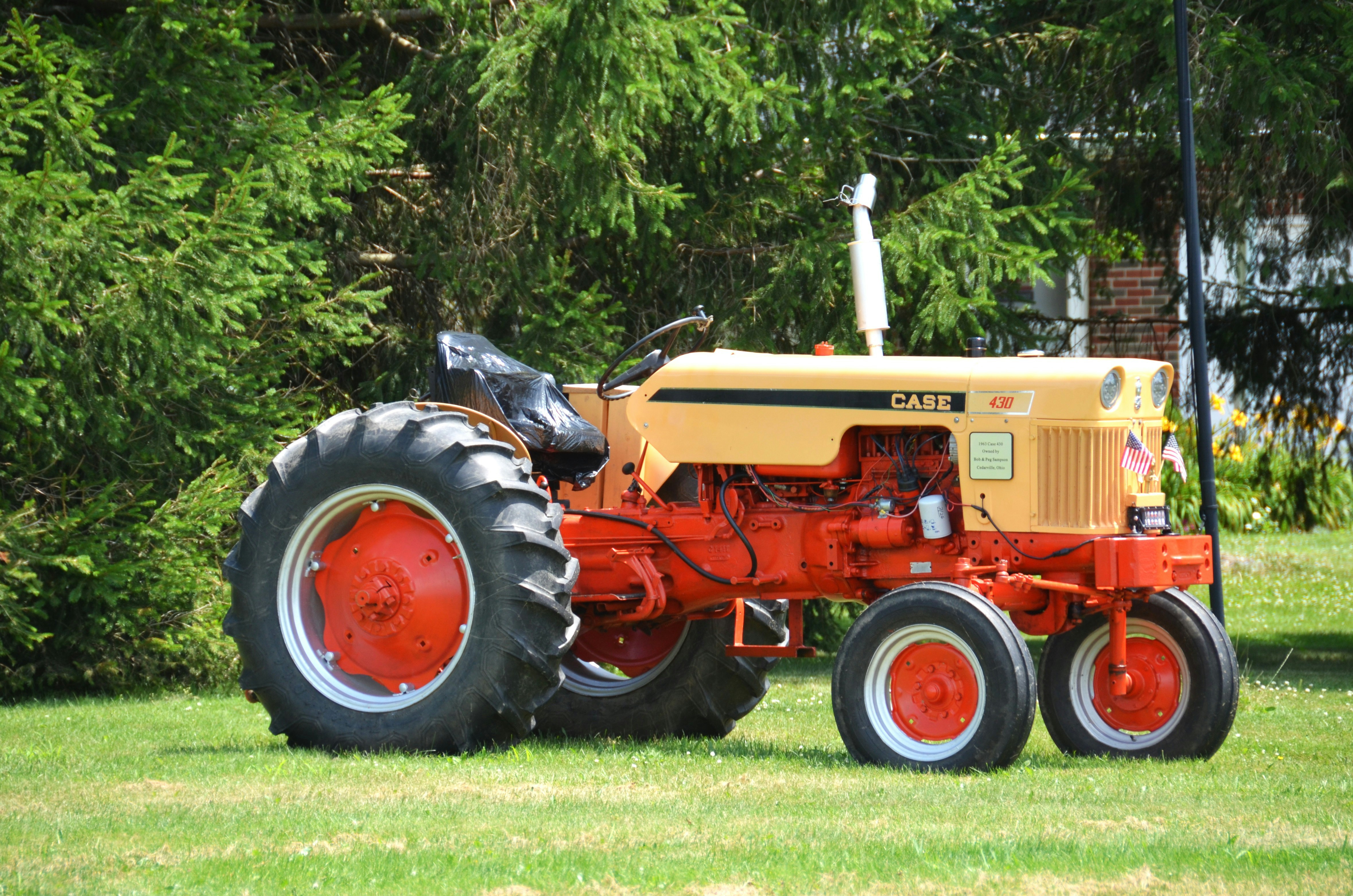 Orange Power: A Classic Farm Tractor Resting on Lush Green